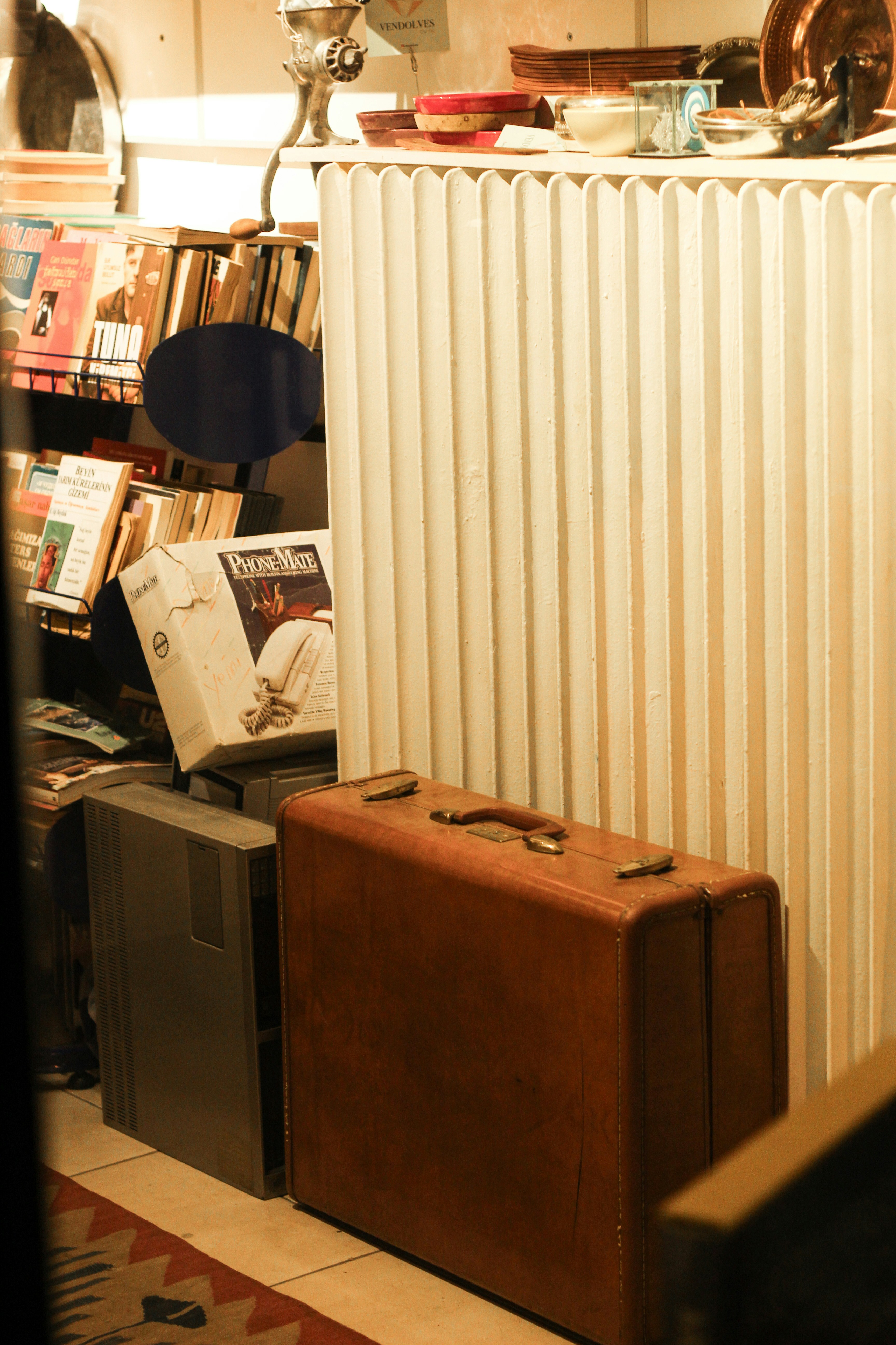 Hushed Burden: A Vintage Suitcase in a Sunlit Nook