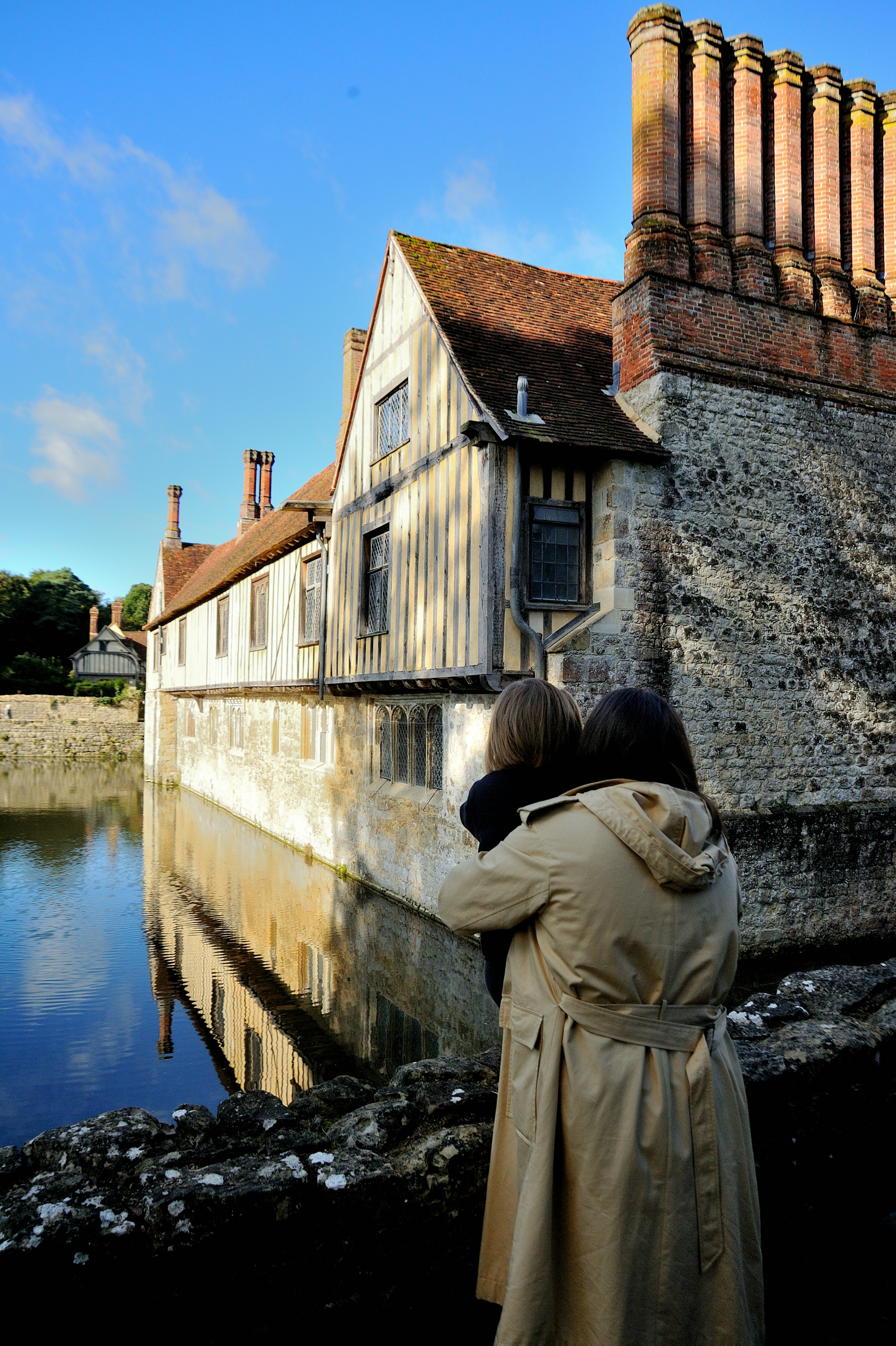 A woman standing next to a body of water photo – Free Ightham mote ...