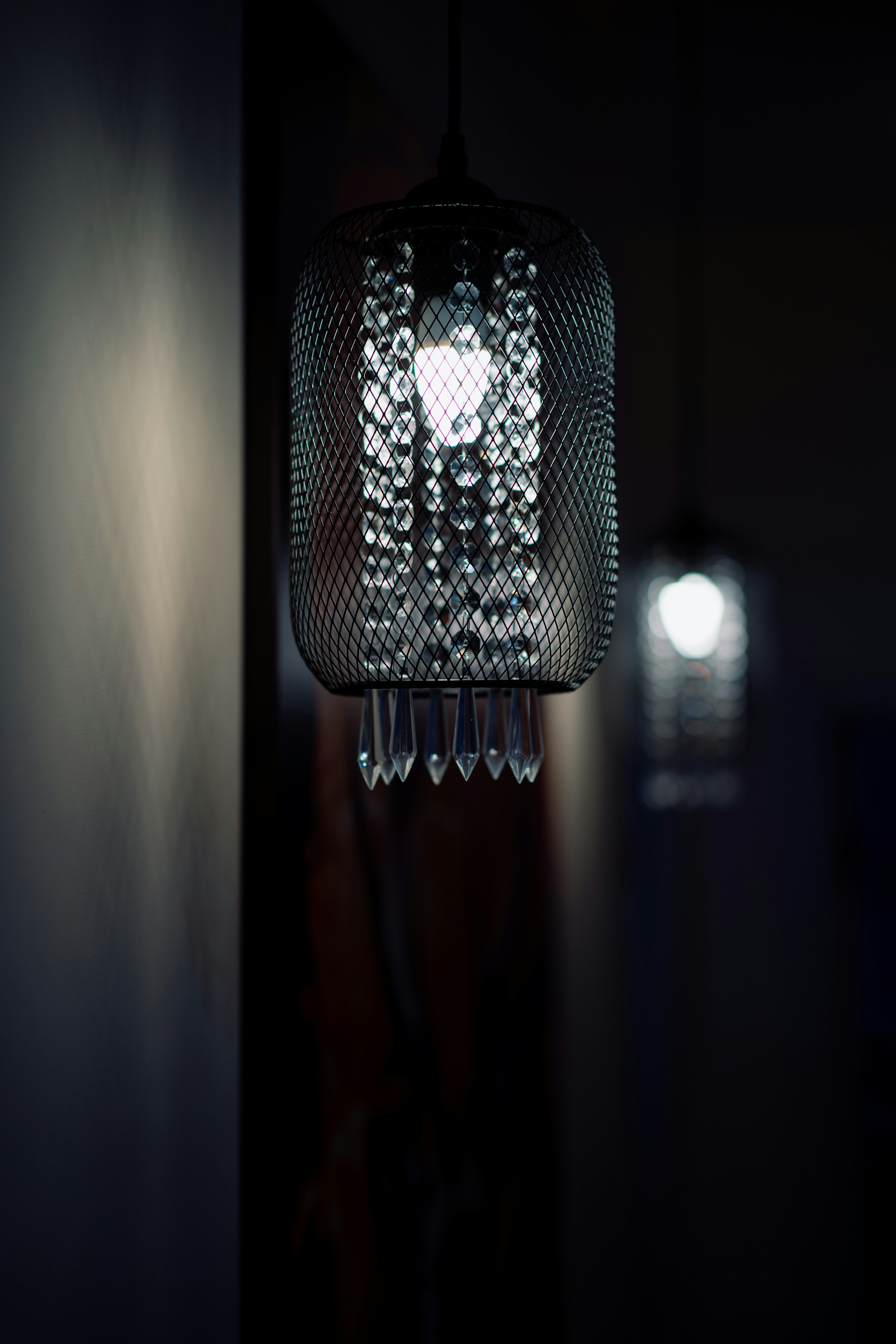 Crystal Mesh Pendant Casting Quiet Light in a Shadowed Corridor