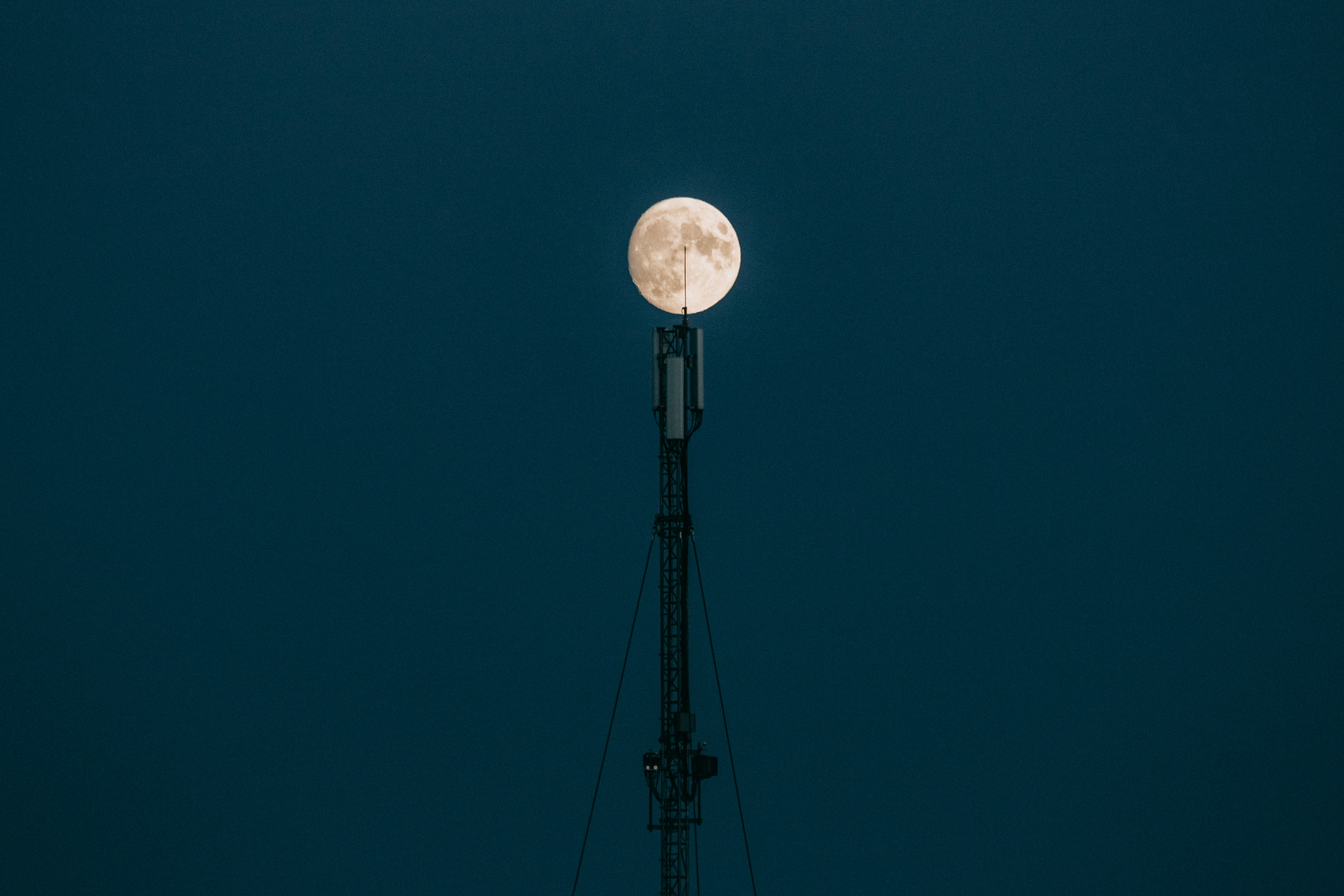 Moonrise on the Mast: a lone tower silhouettes against velvet night