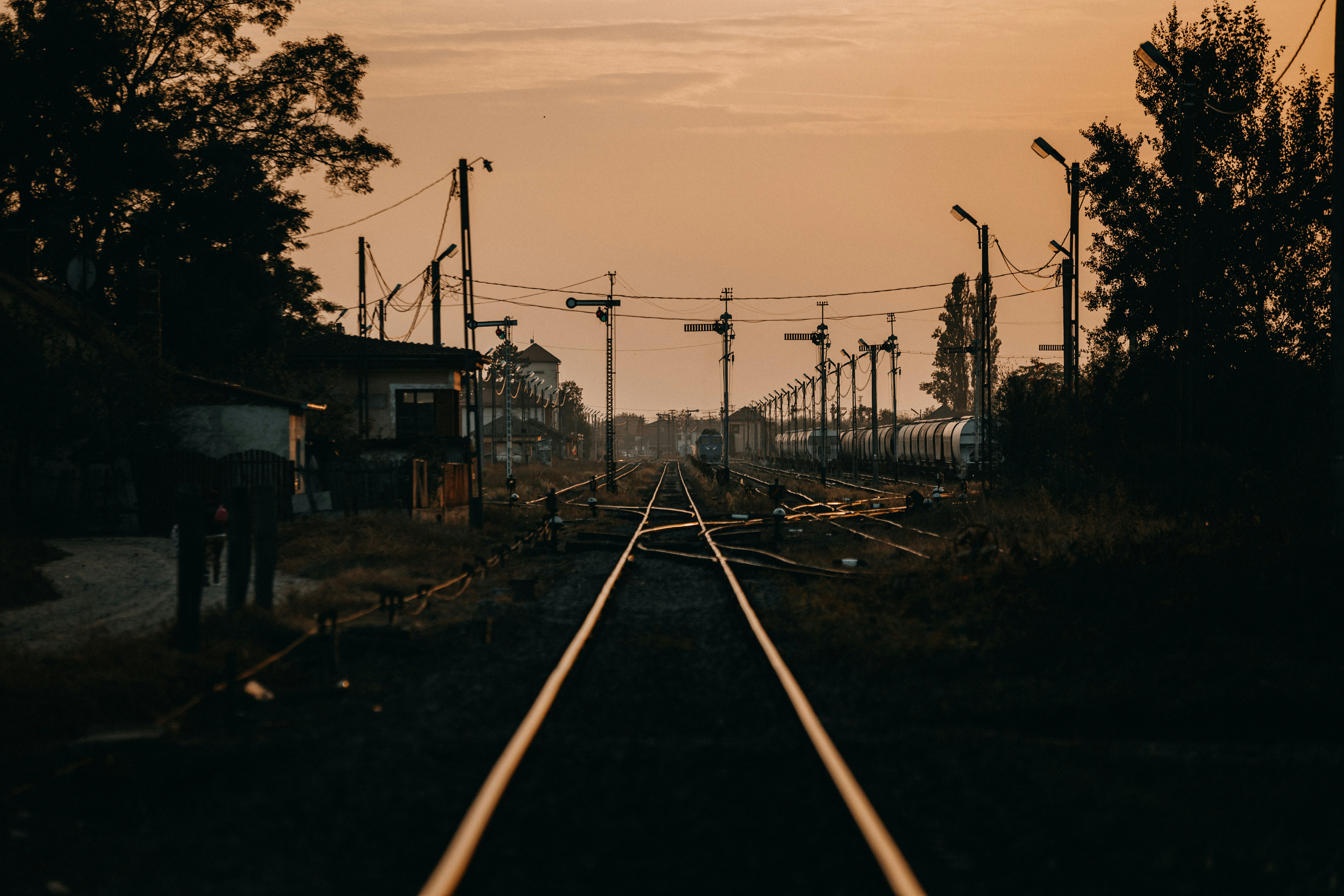 A train track running through a rural area photo – Free Sunset Image on ...