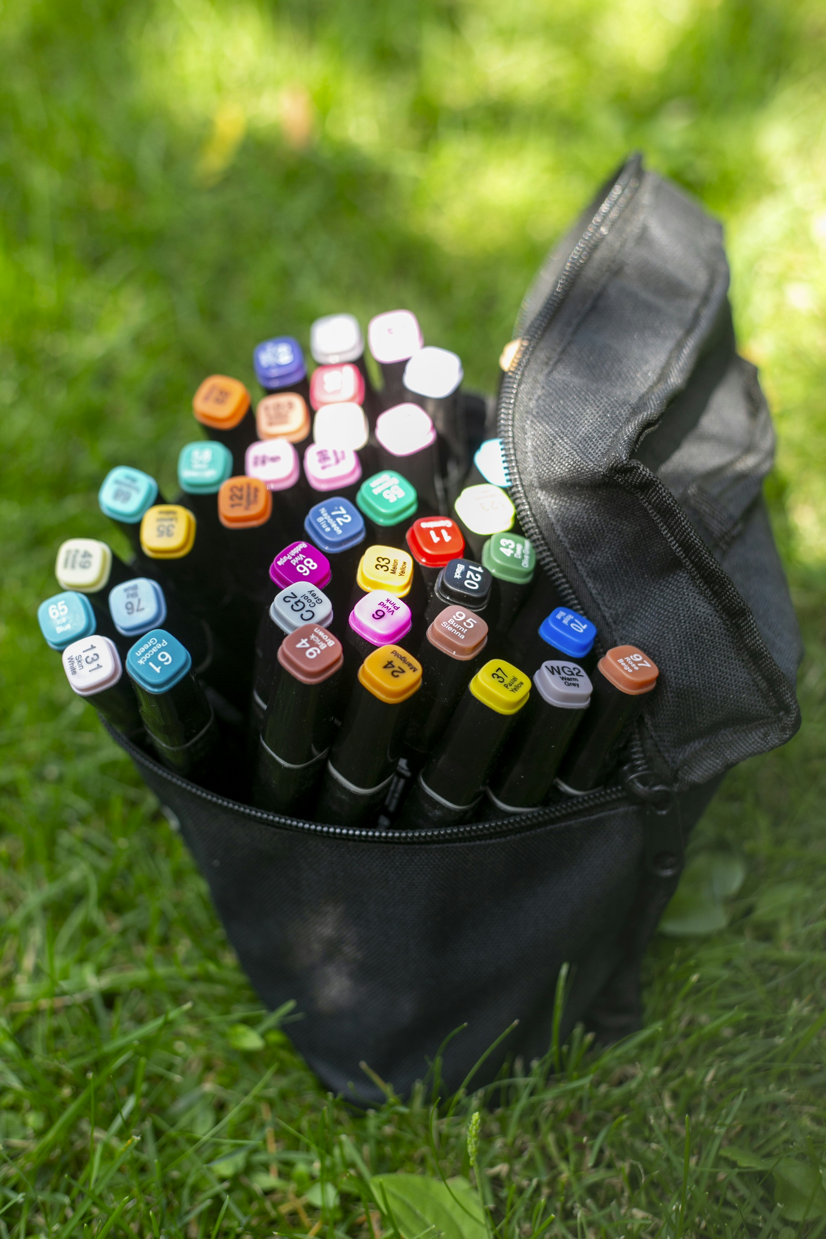 A black bag filled with lots of different colored markers photo – Free ...