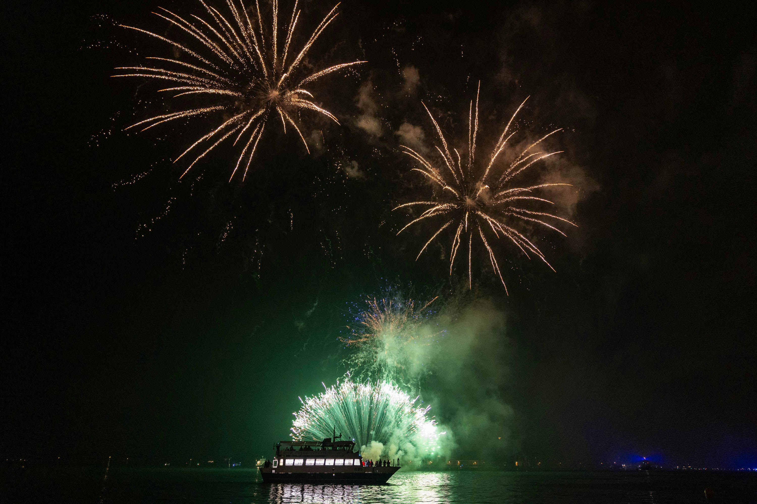 A large fireworks display over a body of water photo – Free Italy Image ...
