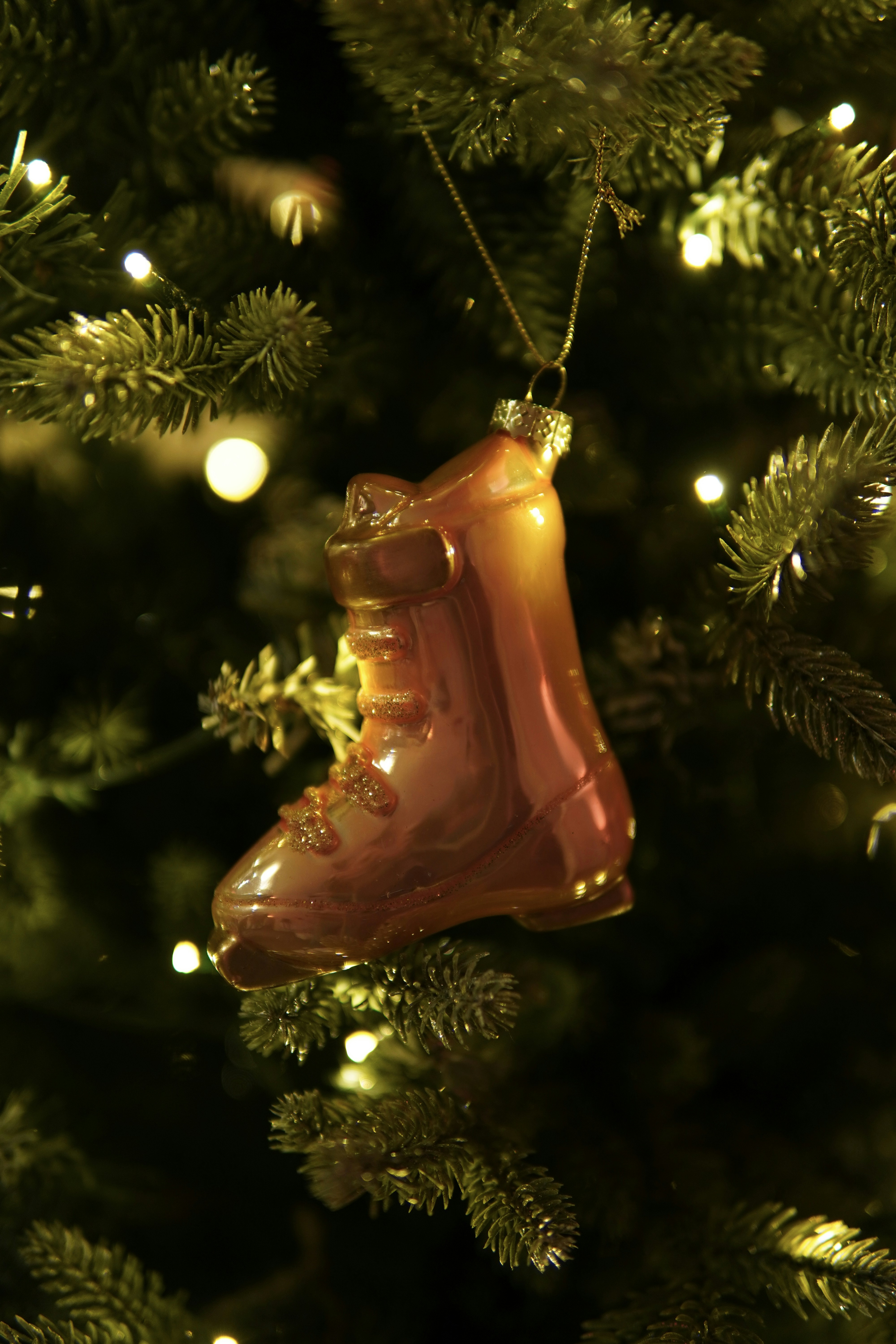 Pink Ice Skate Ornament Dangles Through a Halo of Christmas Lights