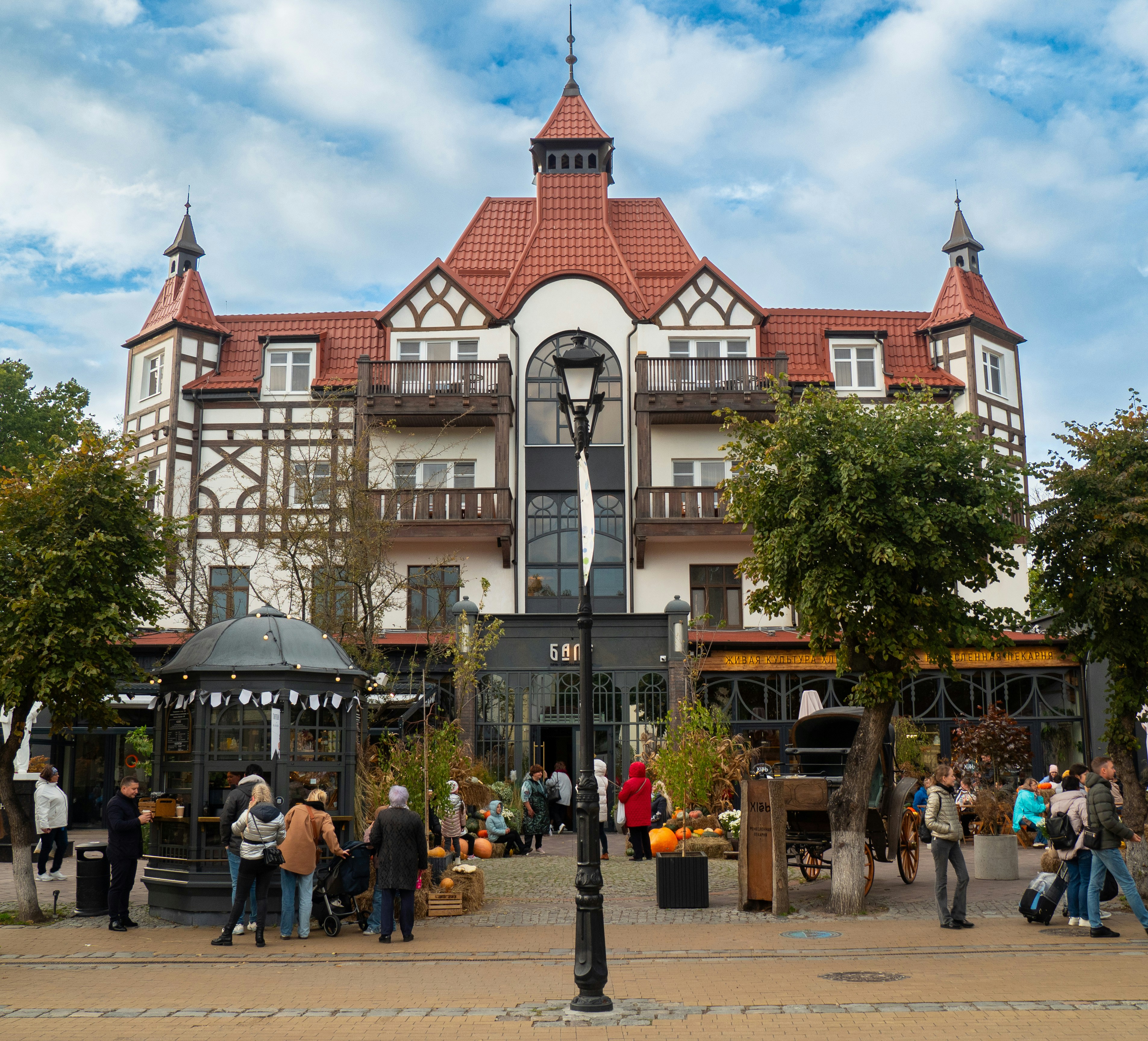 Market Day Beneath the Fairytale Facade: Timber-Framed Grandeur in a Lively Town Square