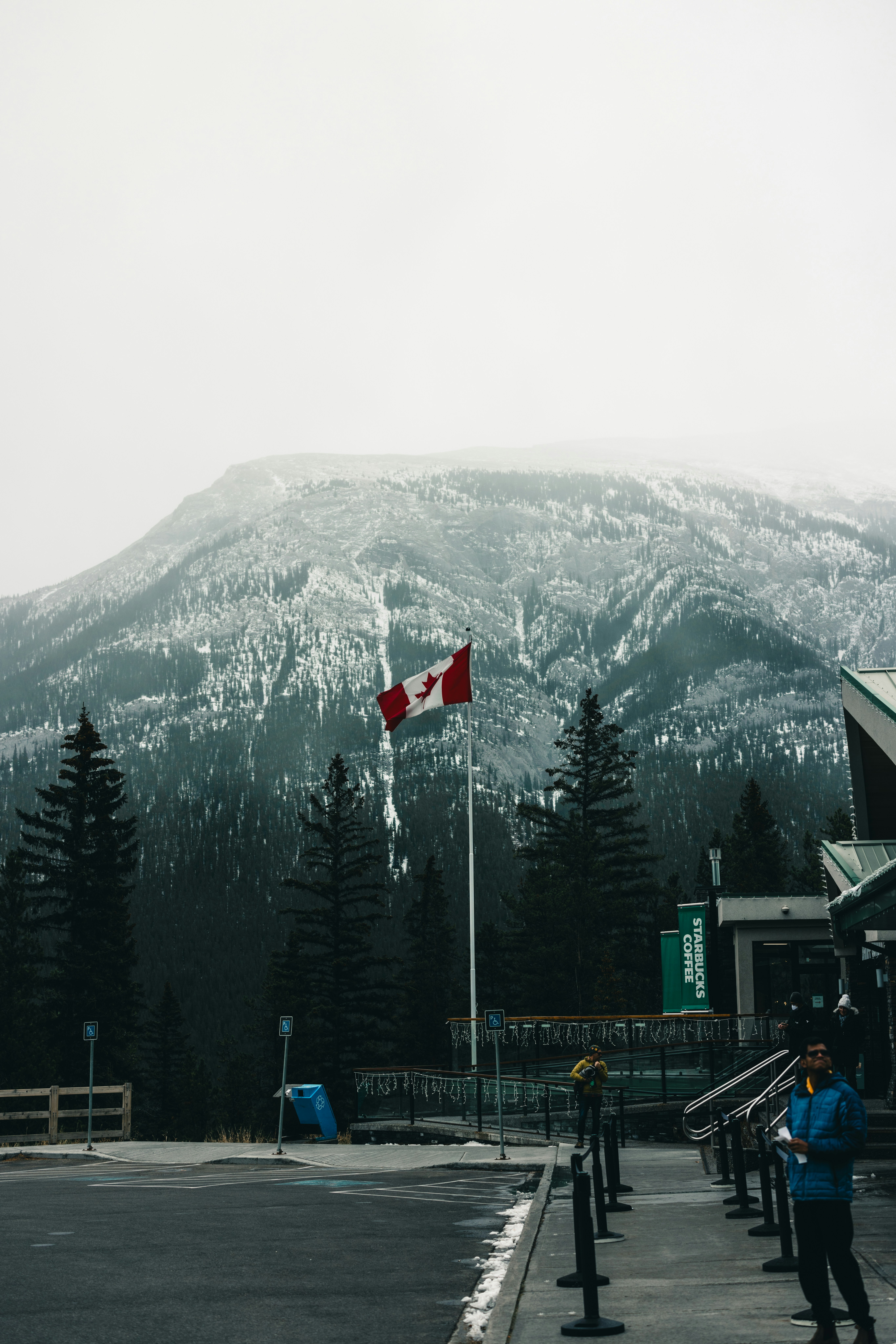A canadian flag flying in front of a mountain photo – Free Canada Image ...