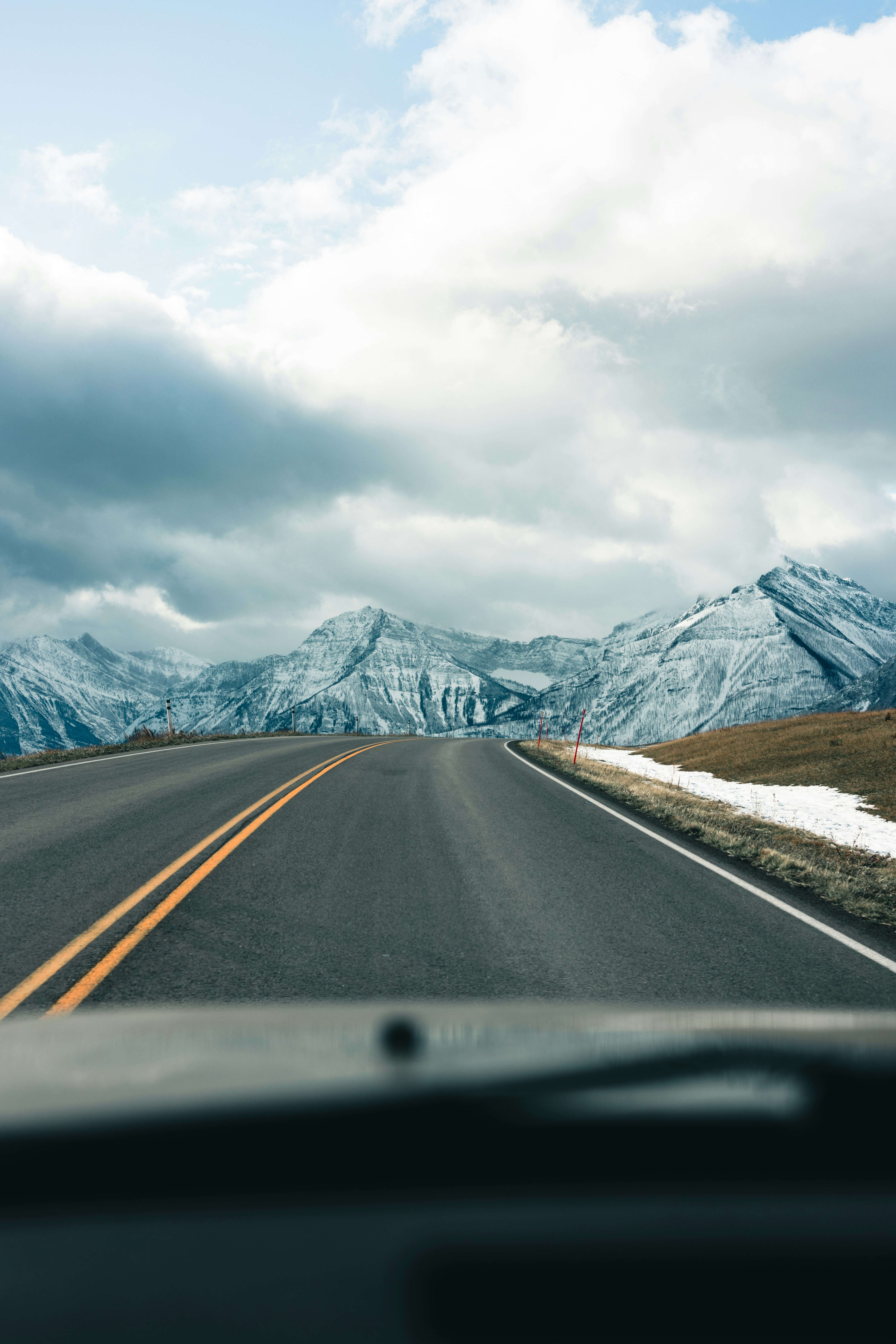 A car driving down a road with mountains in the background photo – Free ...