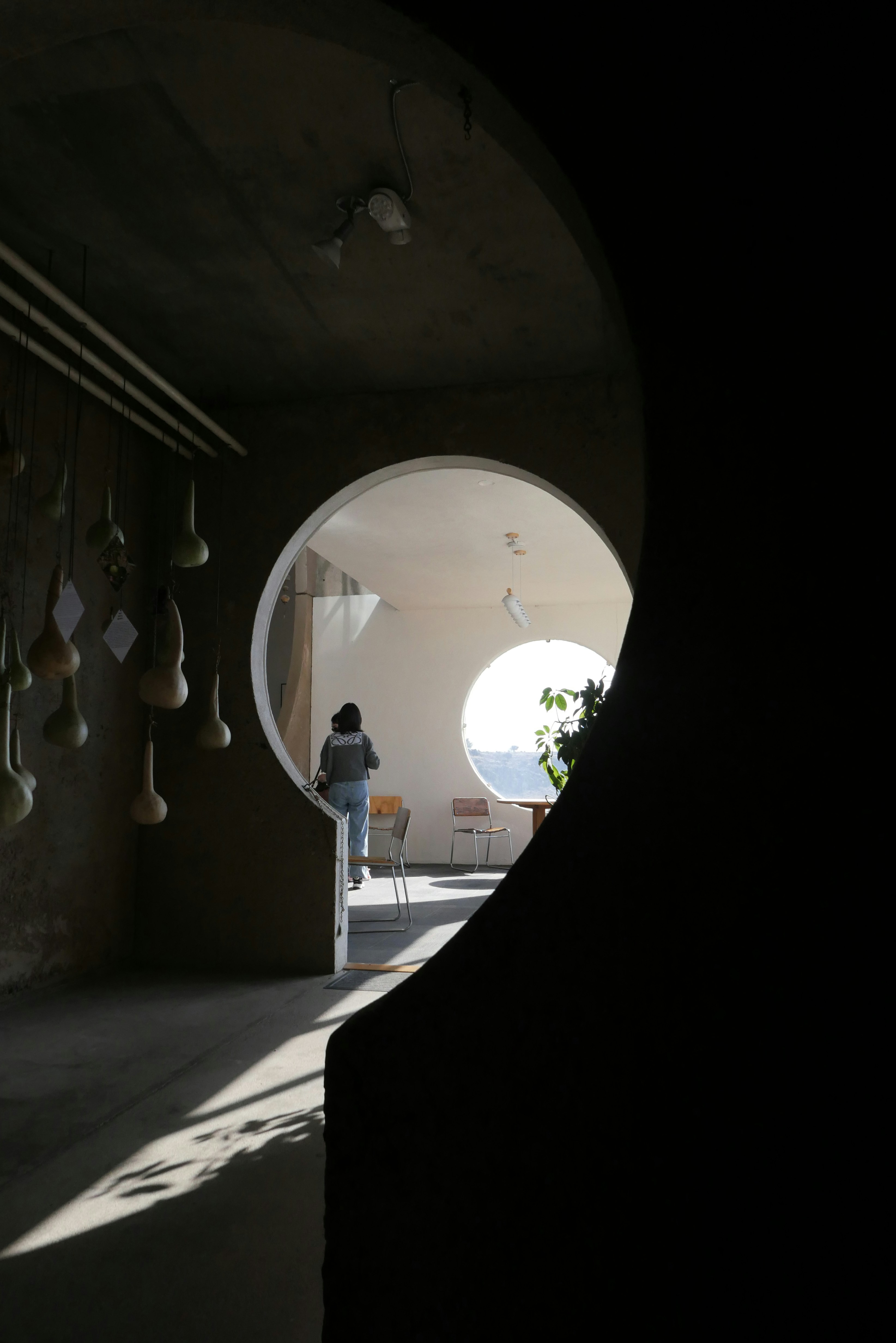 Threshold of Circles: A Quiet Figure in a Sunlit Atrium
