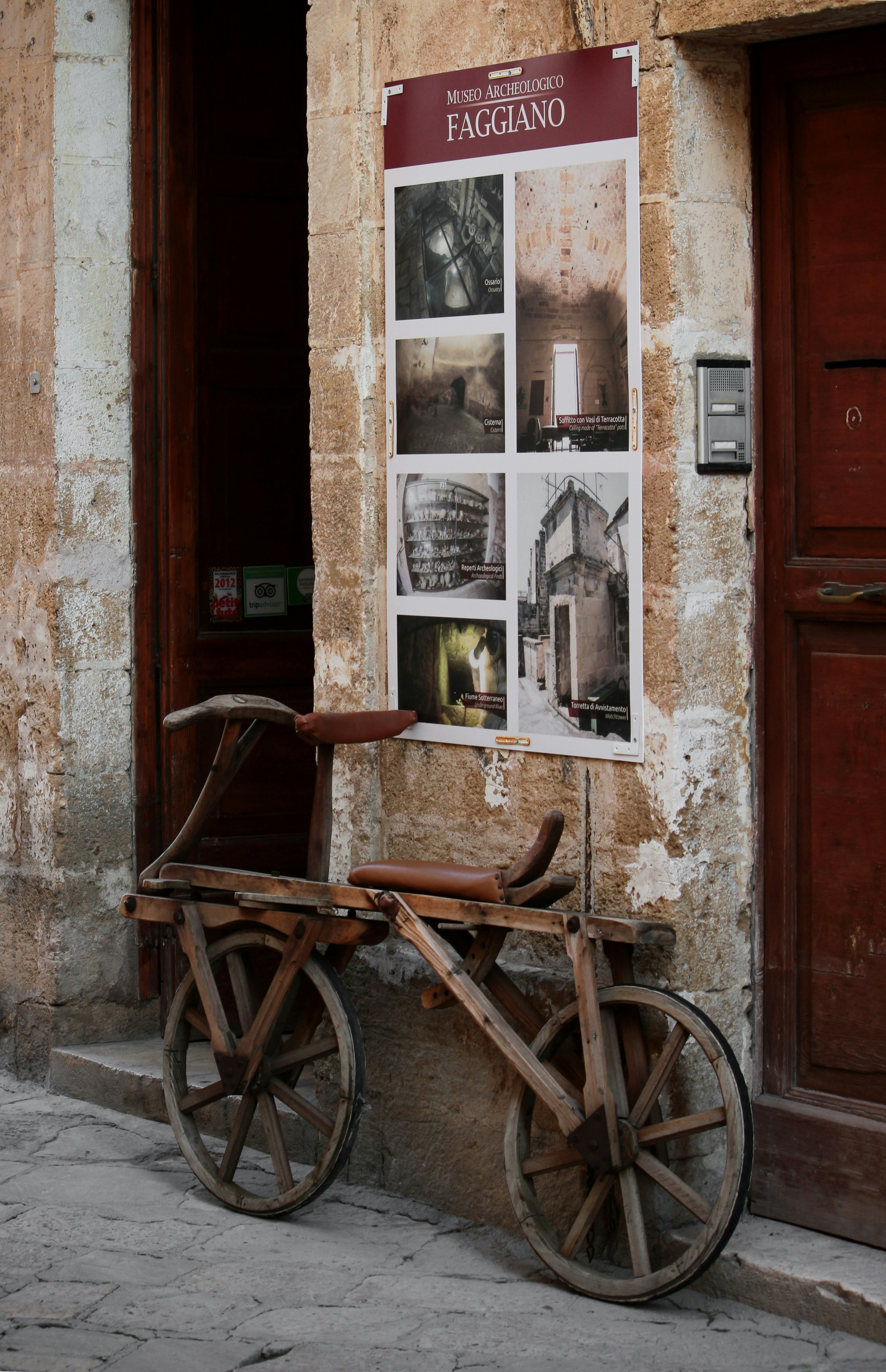 Rust and Signatures: A Wooden Bicycle by a Heritage Poster