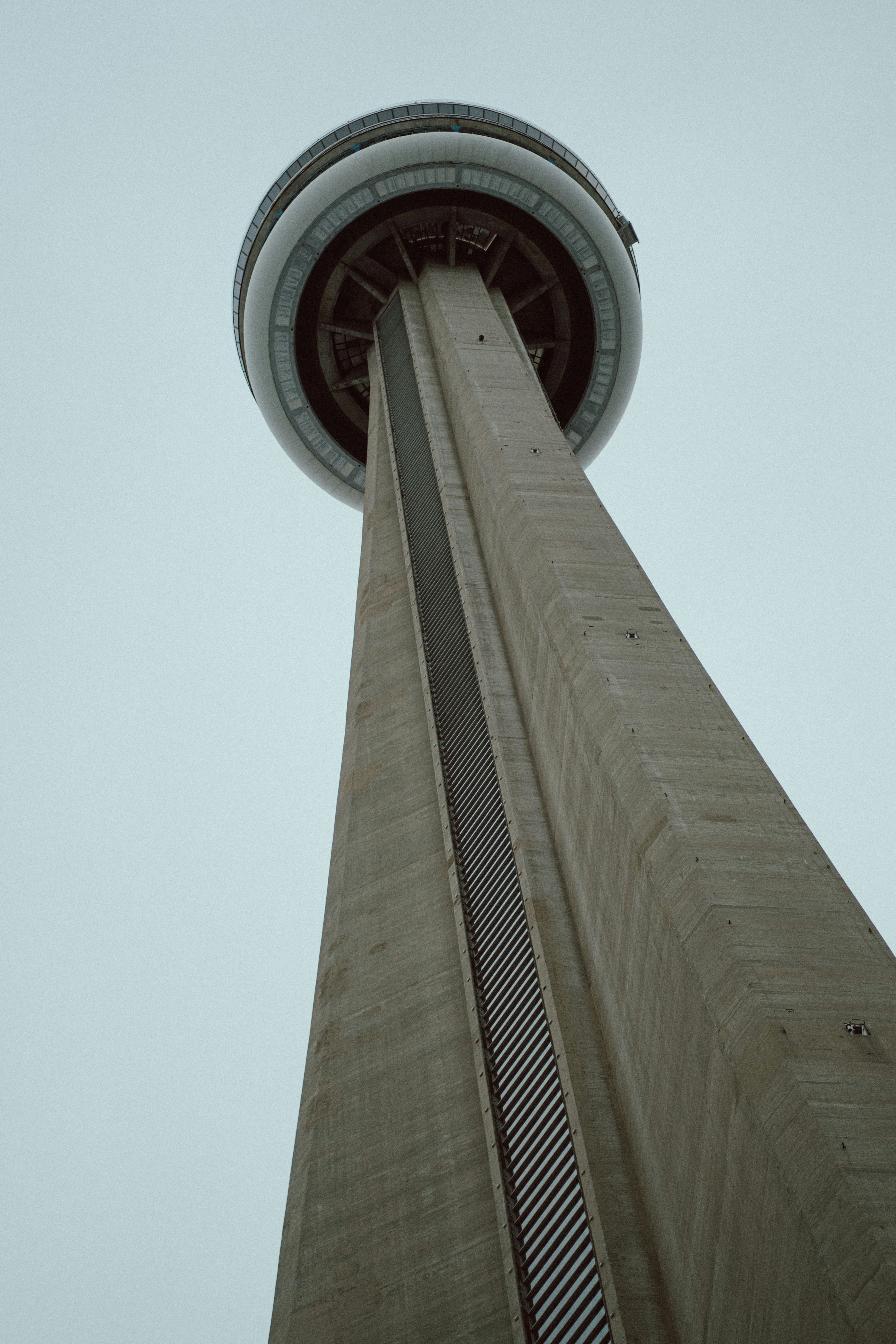 Skyward Spine: The Concrete Tower Piercing a Pale Sky