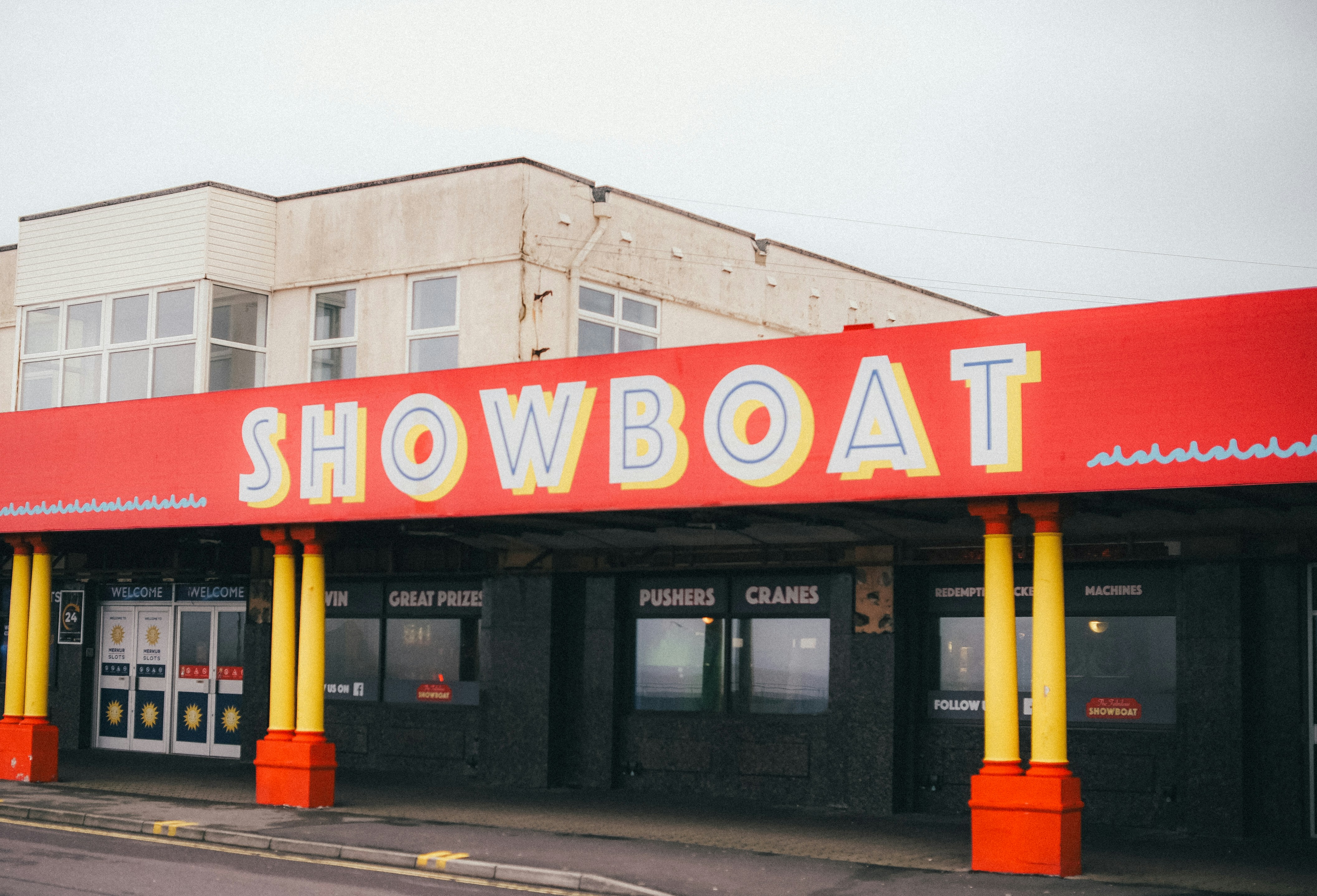 Showboat Signage: Bold Red Facade with Yellow Columns on a Weathered Arcade