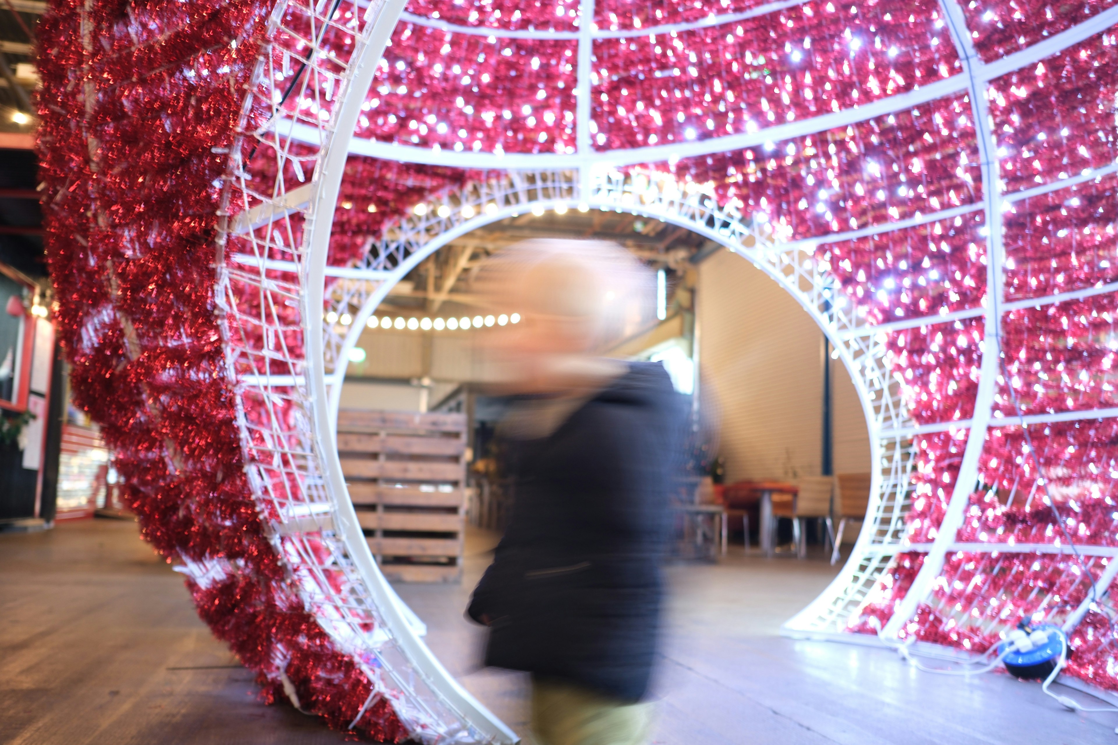 Blurred visitor through a glowing festive tunnel
