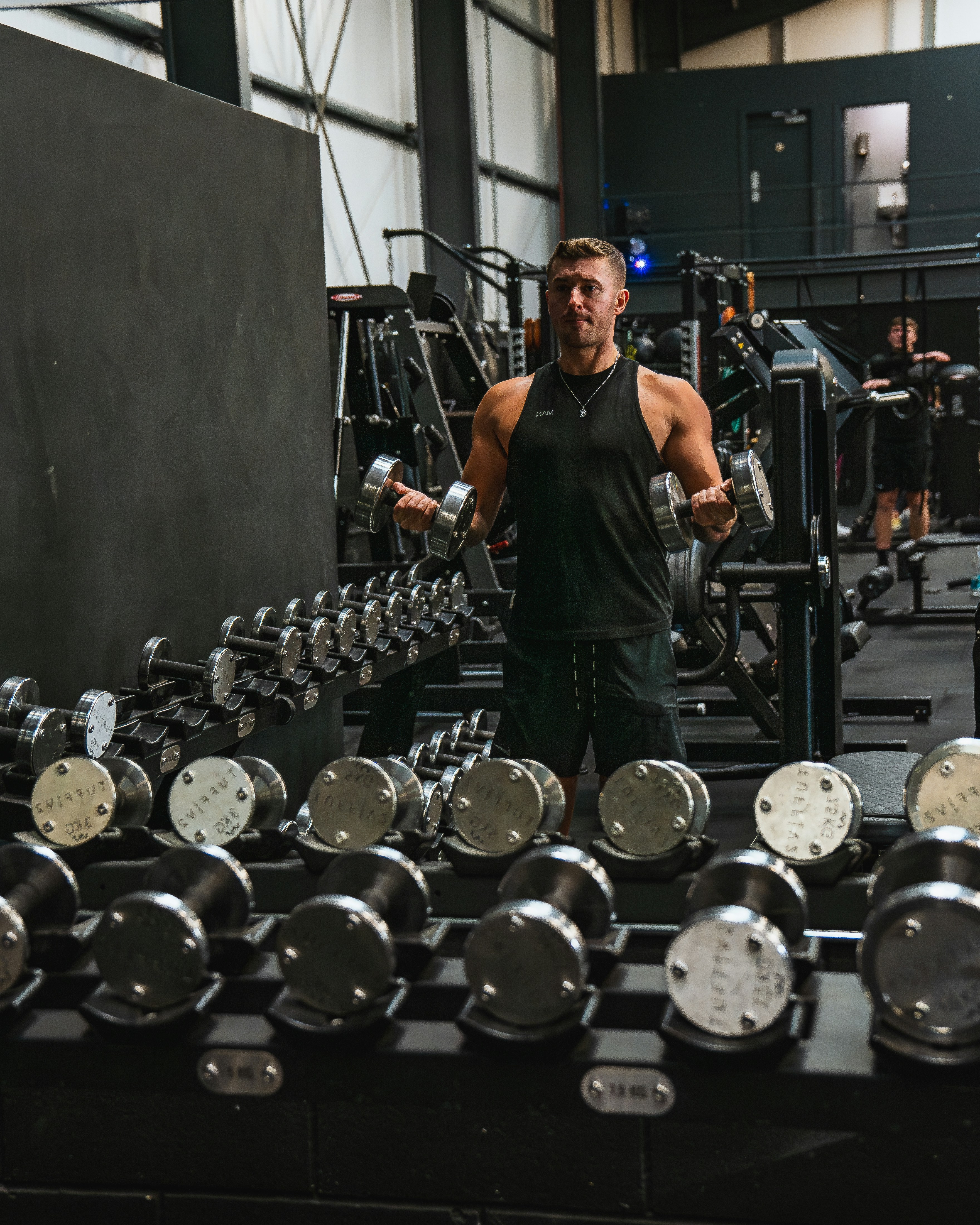 A man standing in front of a bunch of dumbs photo – Free Adult Image on ...