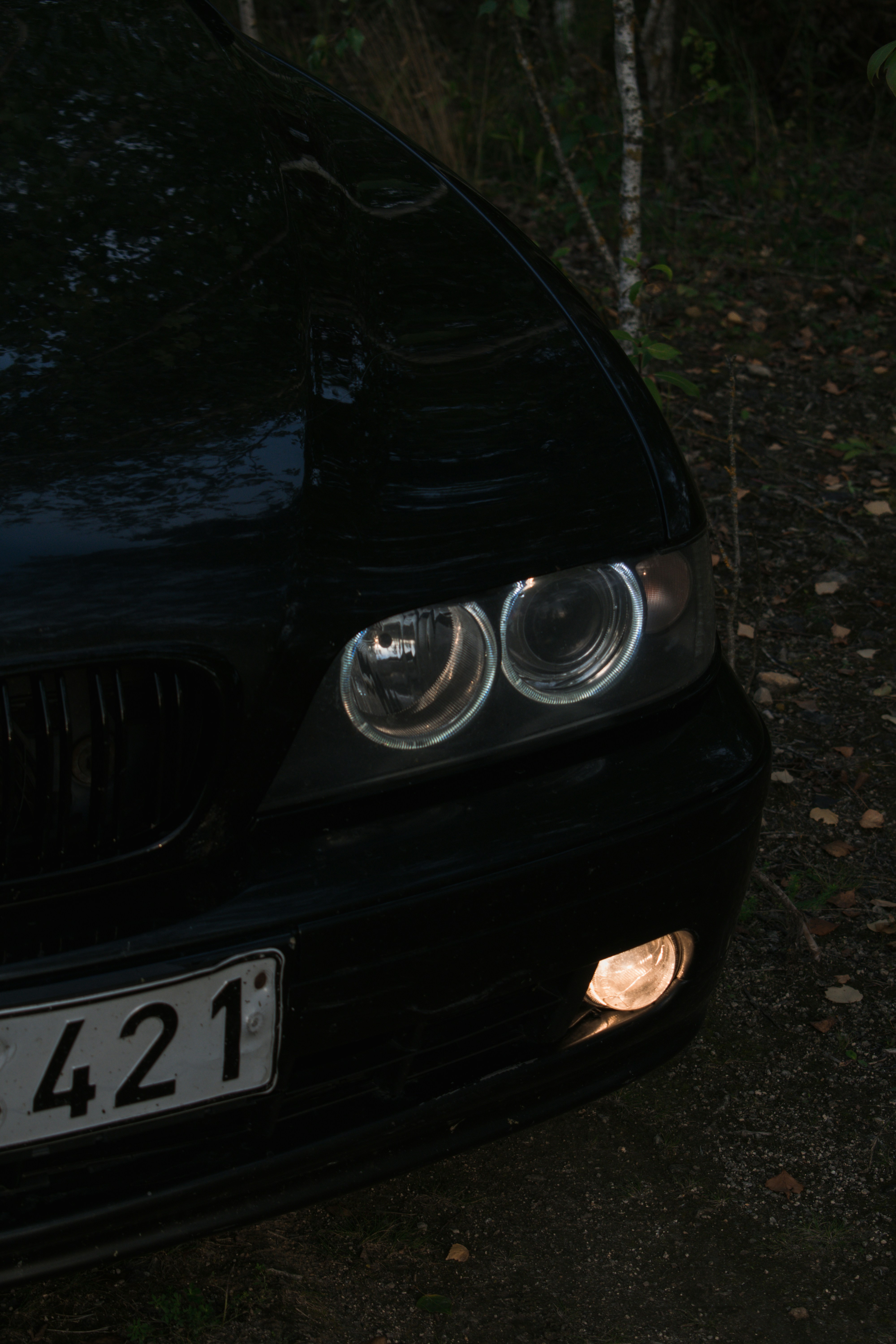 A close up of the headlights of a black car photo – Free Car Image on ...