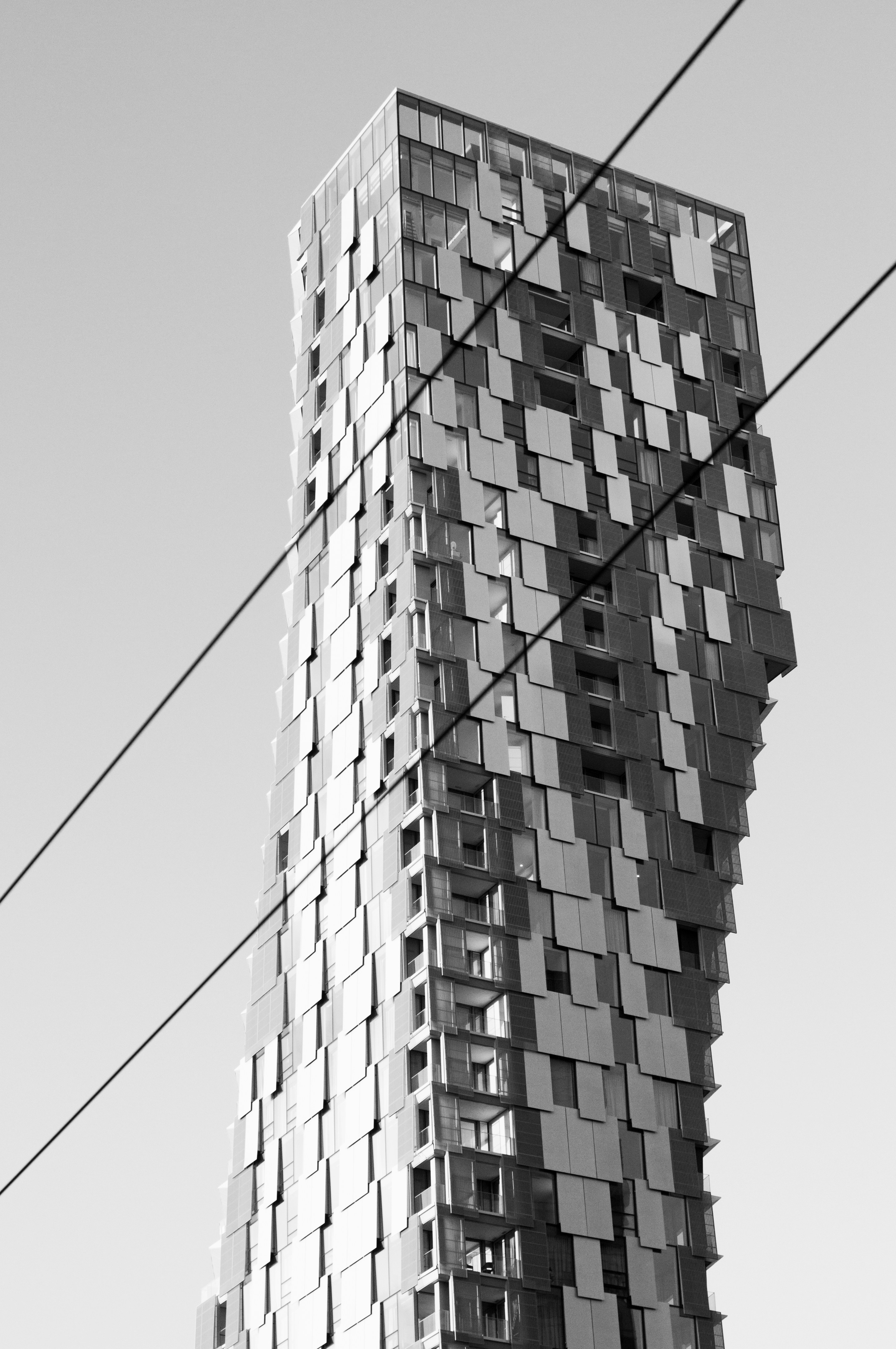 Gridbound Monolith: A Glass Tower Framed by Diagonal Cables