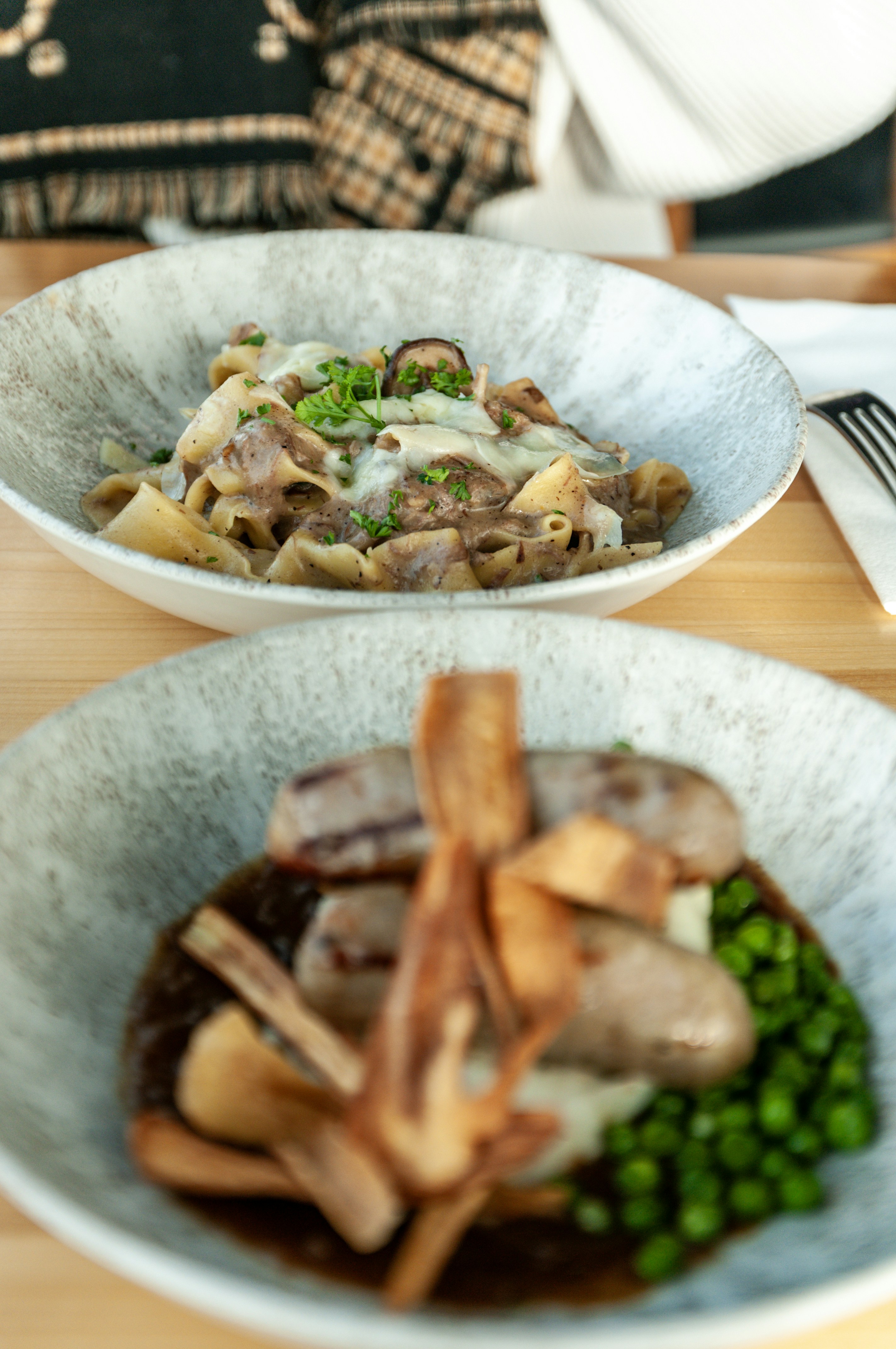 Two-Bowl Comfort: braised mushrooms, greens, and crispy bread on a sunlit wooden table