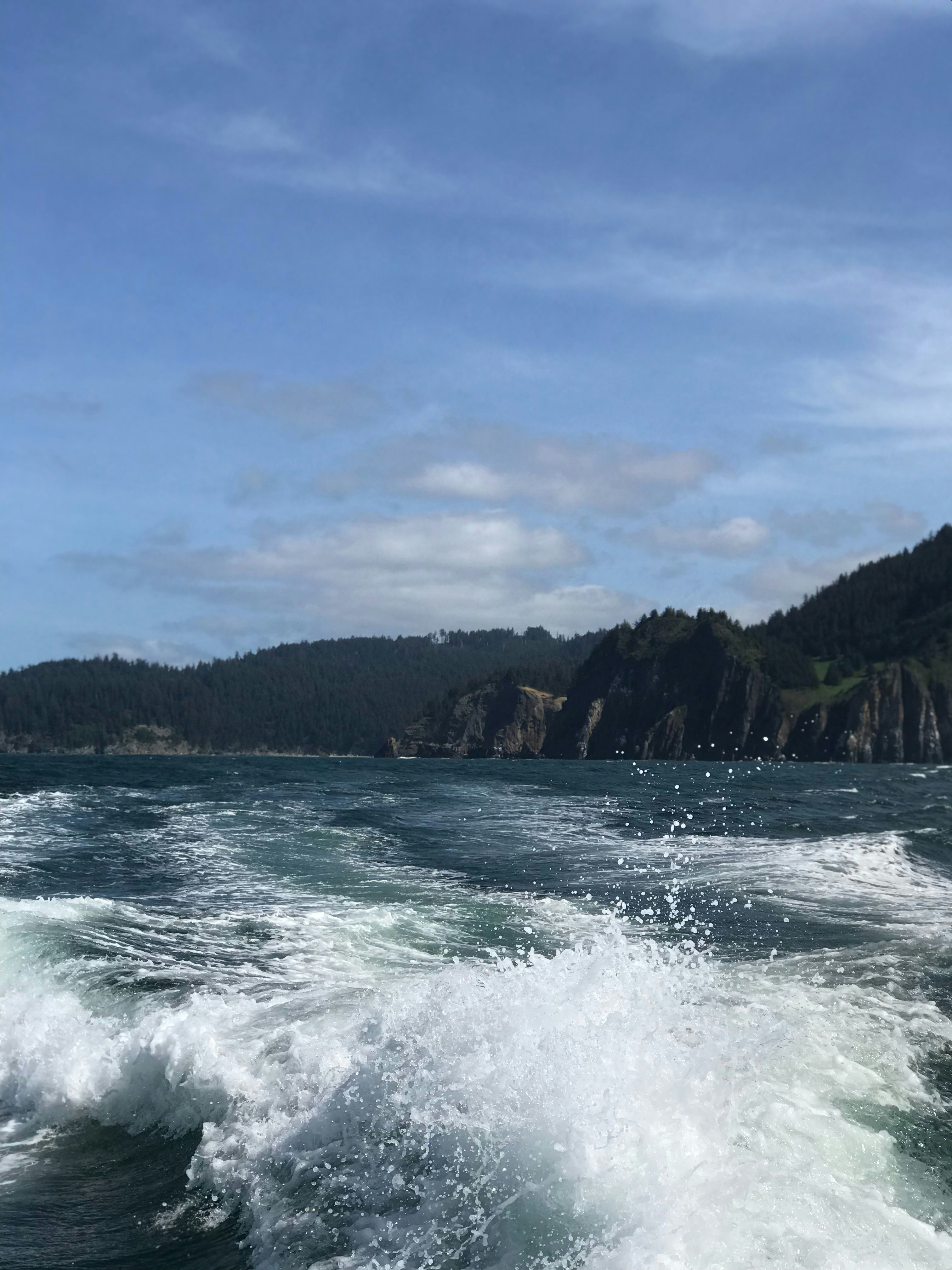 Wake to the Emerald Cliffs: Coastal Horizon from a Motorboat