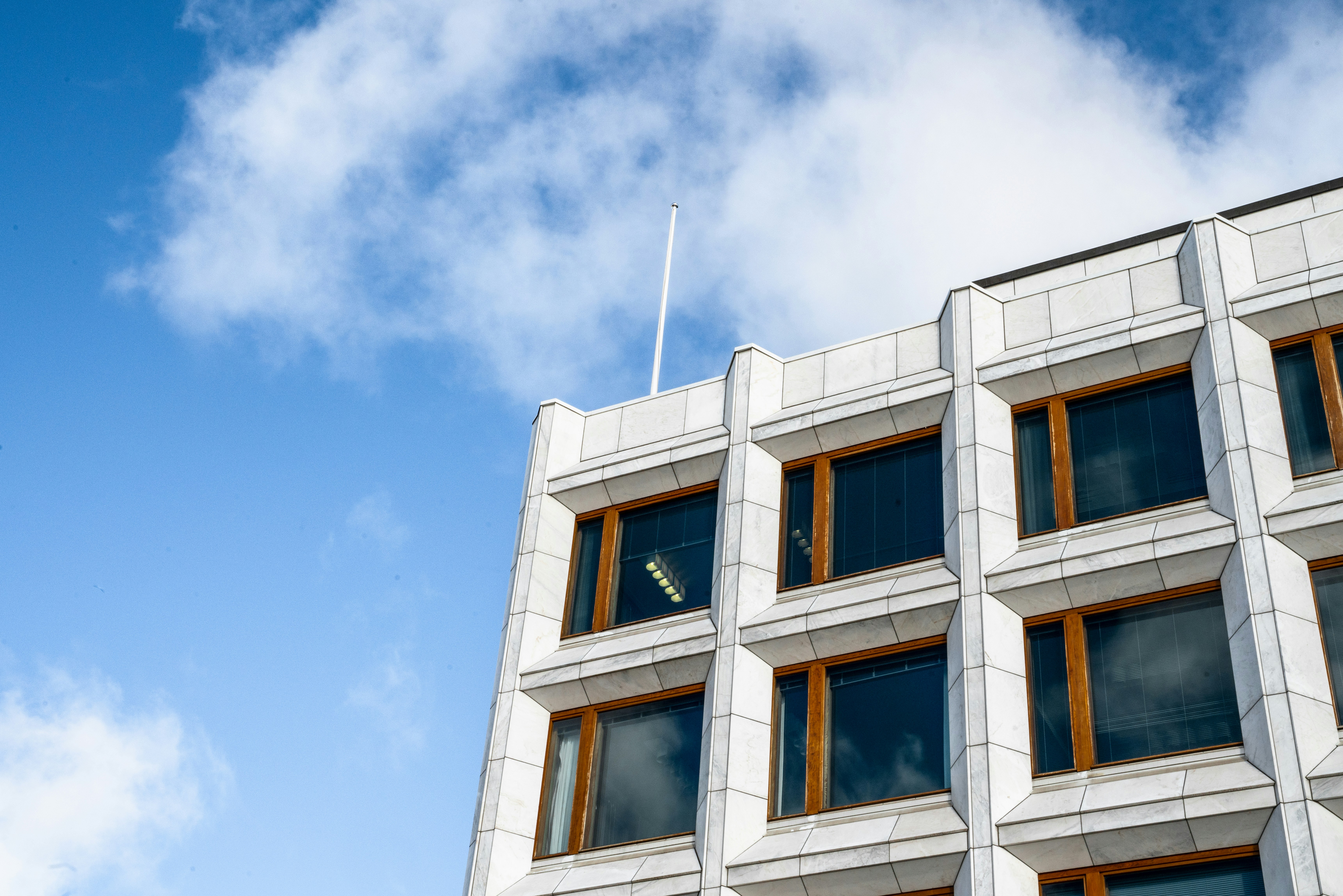 A tall white building with lots of windows photo – Free Building Image ...