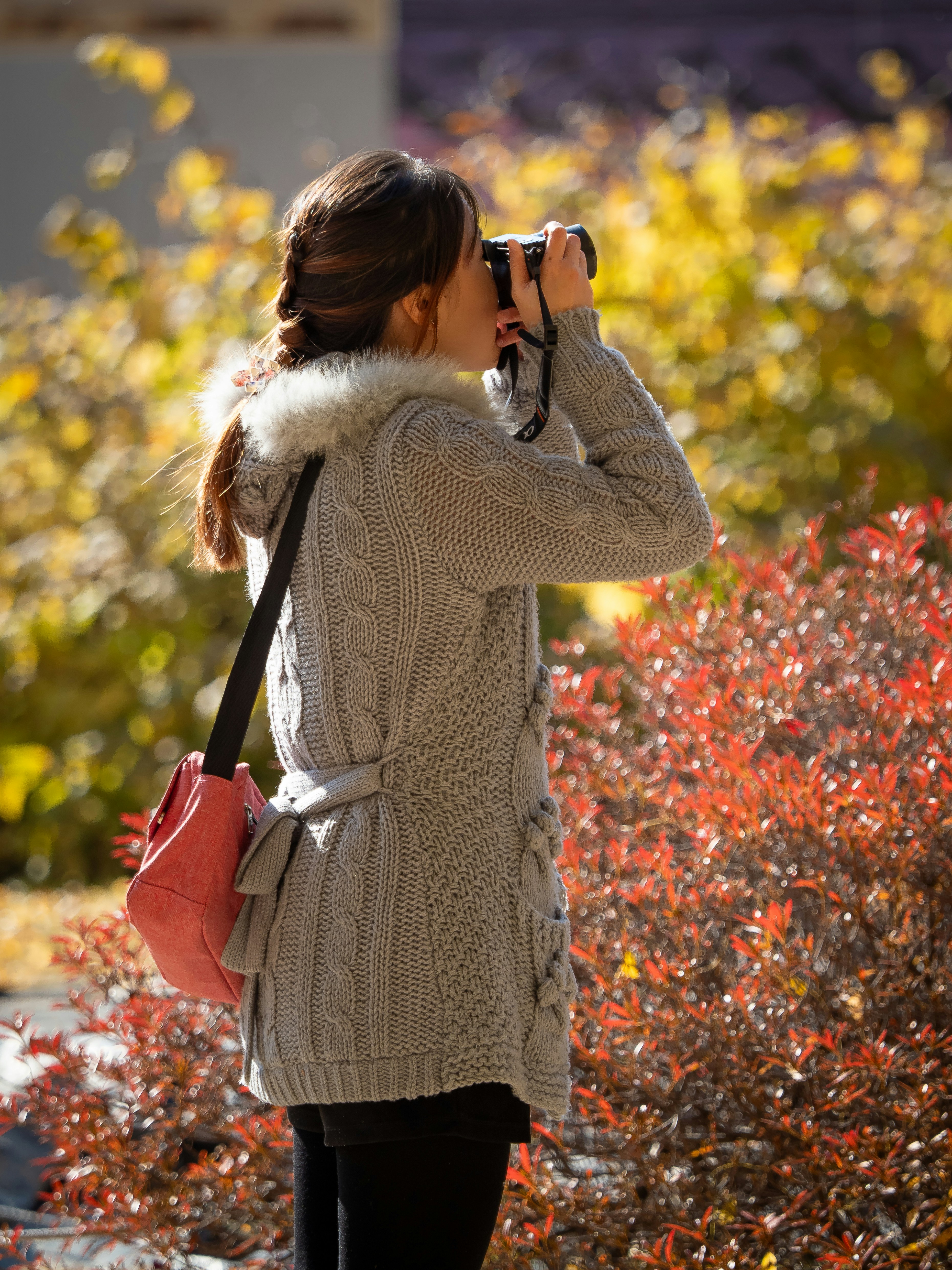 Autumn Focus: A Cozy-Knit Photographer Framing Colorful Light