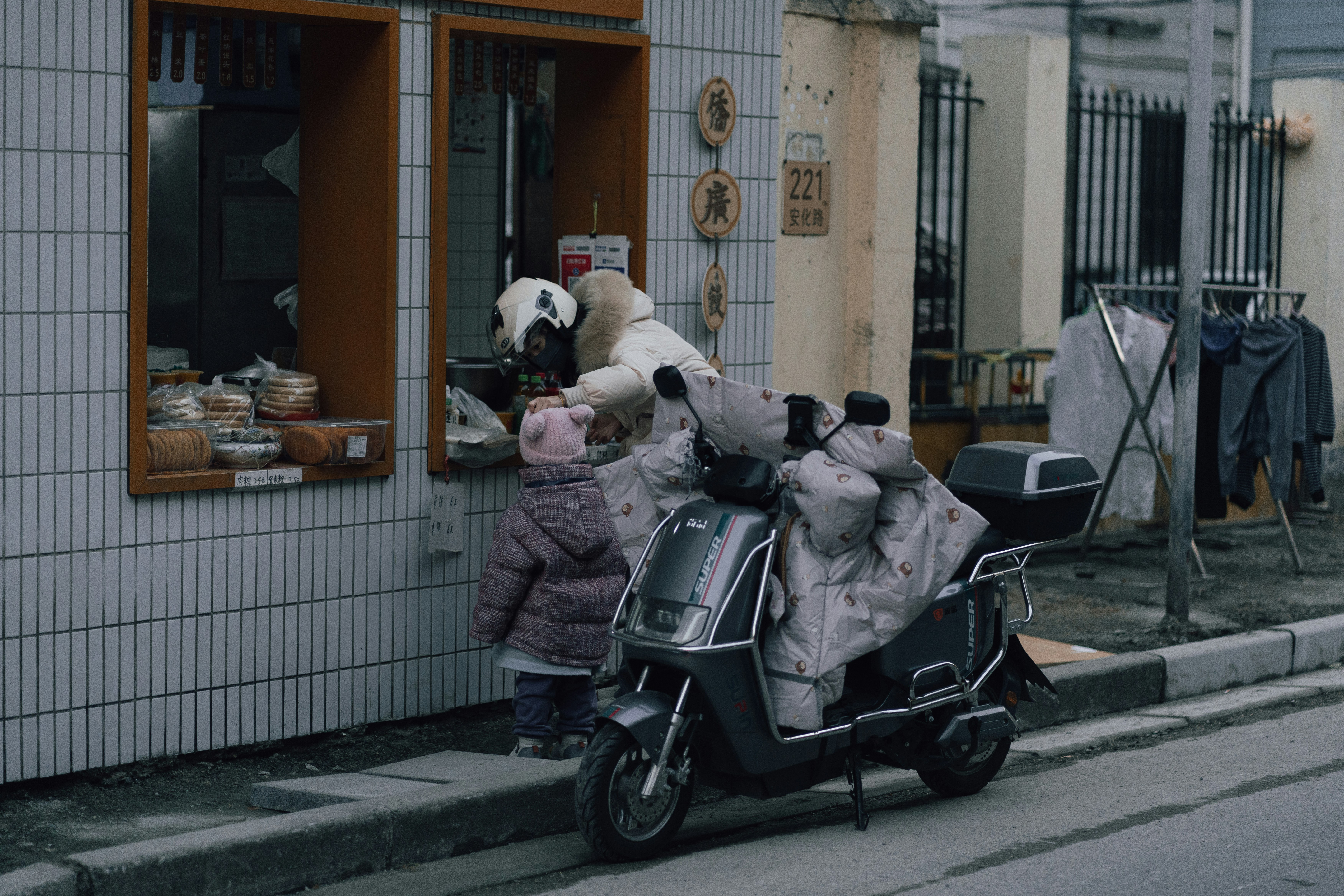 Scooter Café: Steam of Winter Greetings at a Neighborhood Window