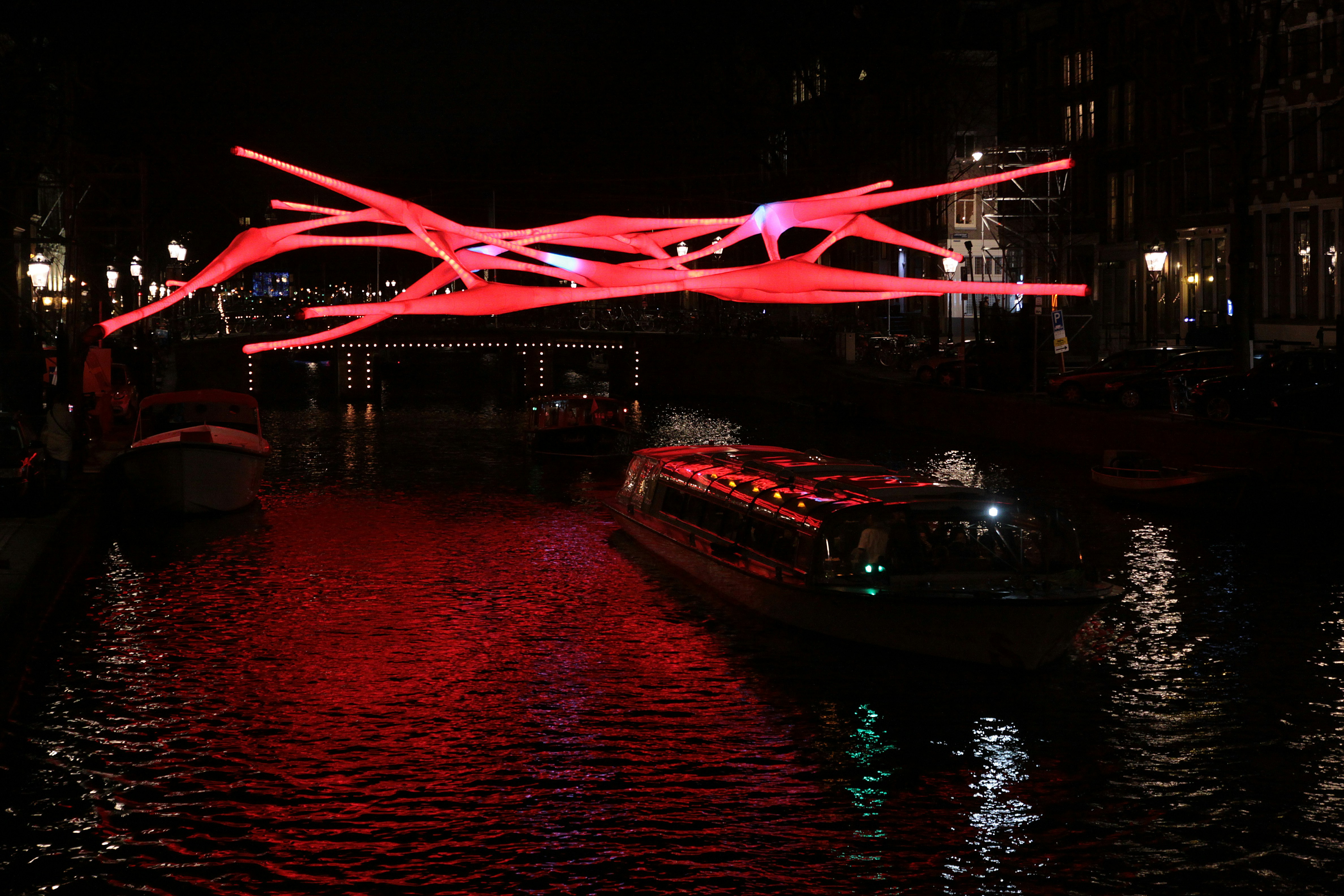 Crimson Neon Ribbon Spanning the Night Canal