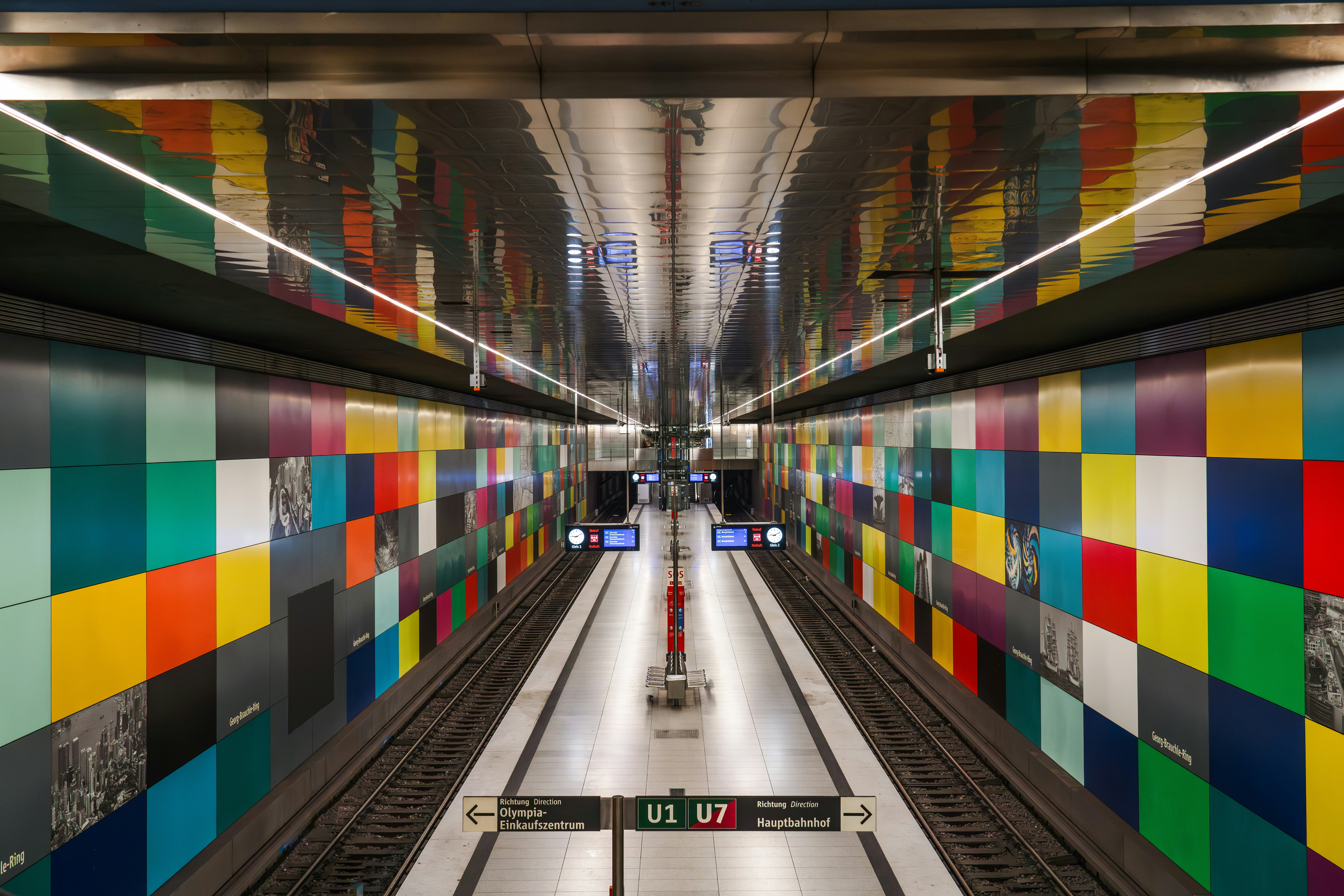 Prismatic Rails: A Centered Descent into a Multicolor Subway Corridor