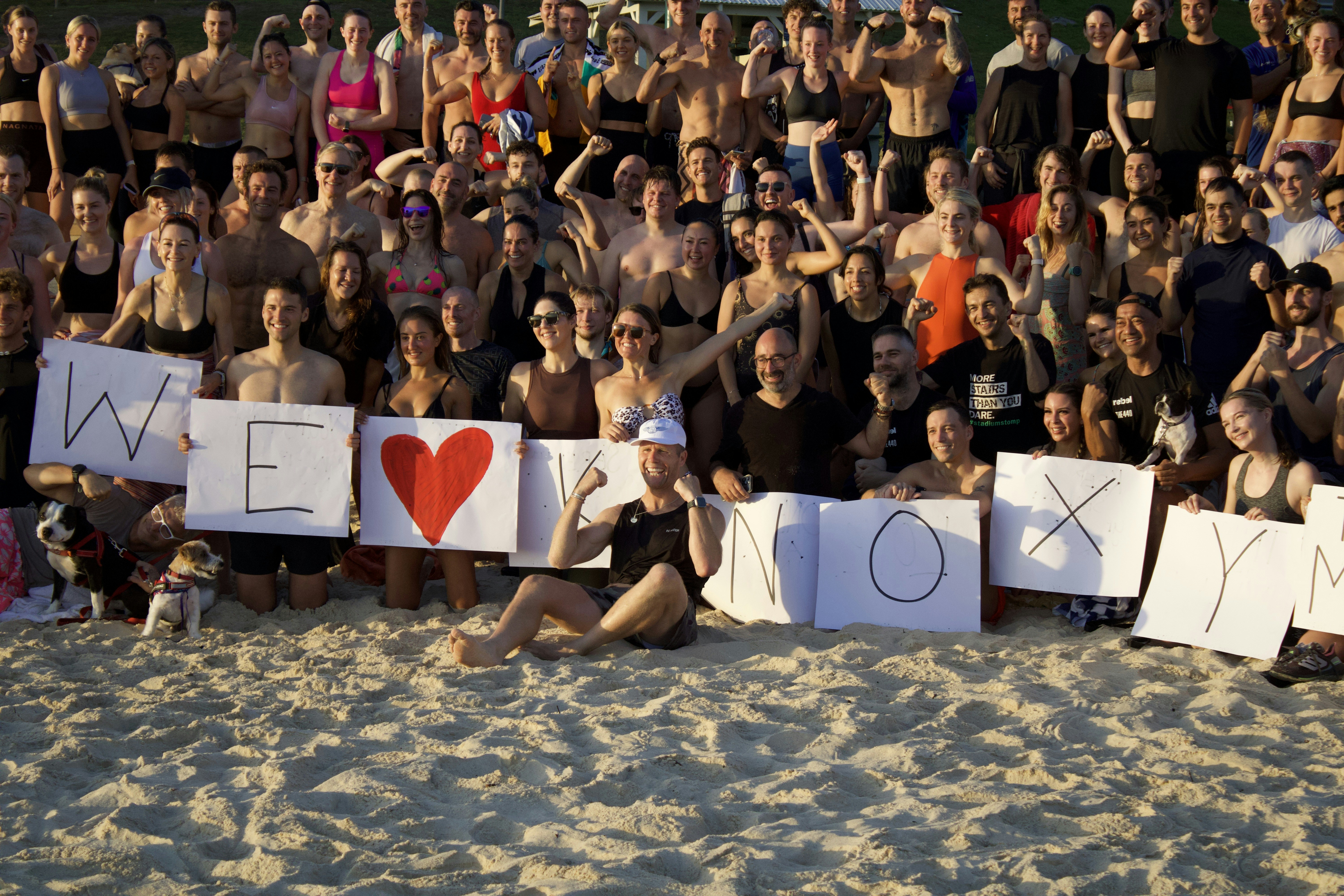 Heartfelt Handwritten Message Rises Across a Sunlit Beach Crowd