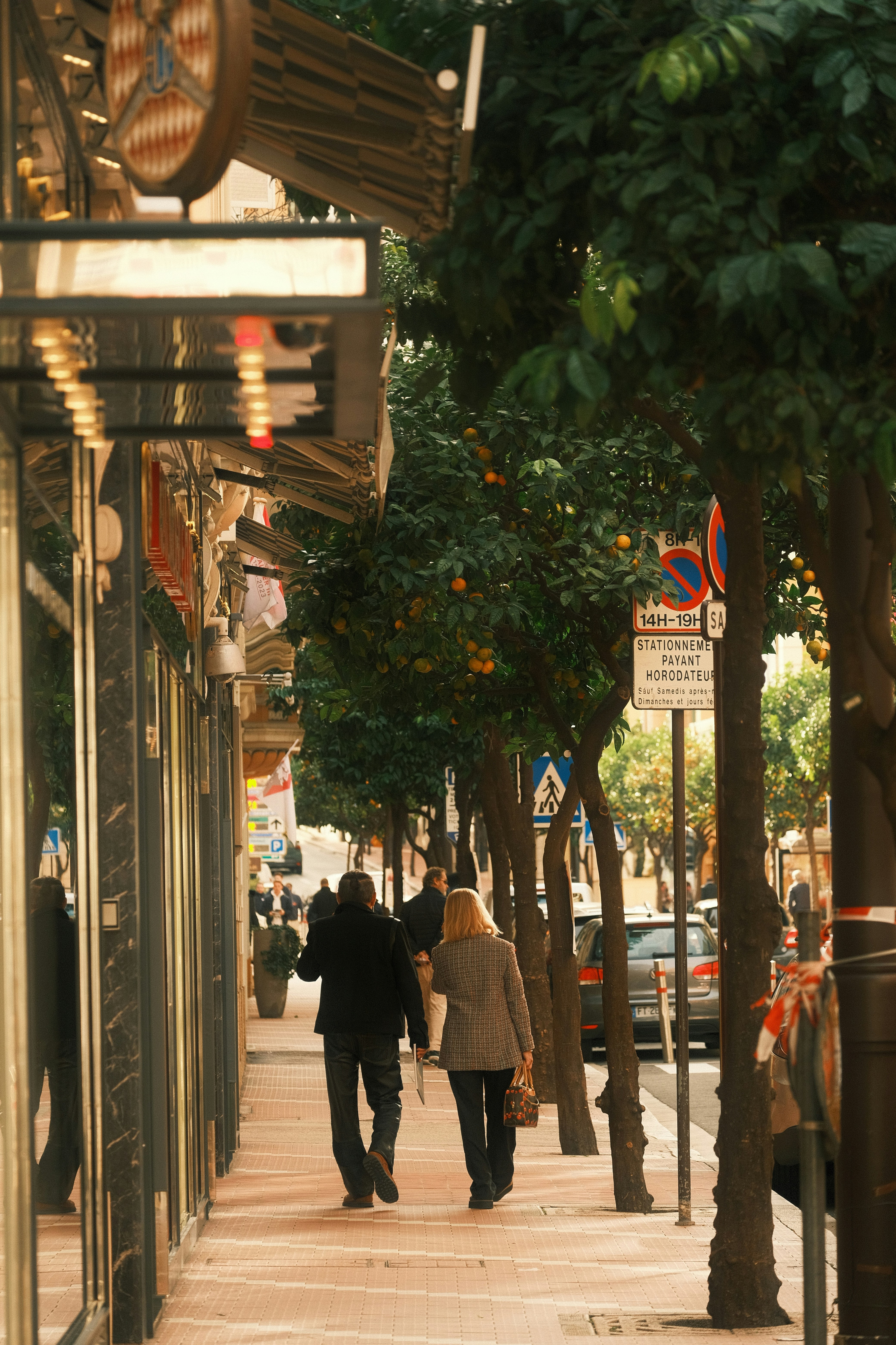 A man and a woman walking down a sidewalk photo – Free Monaco Image on ...
