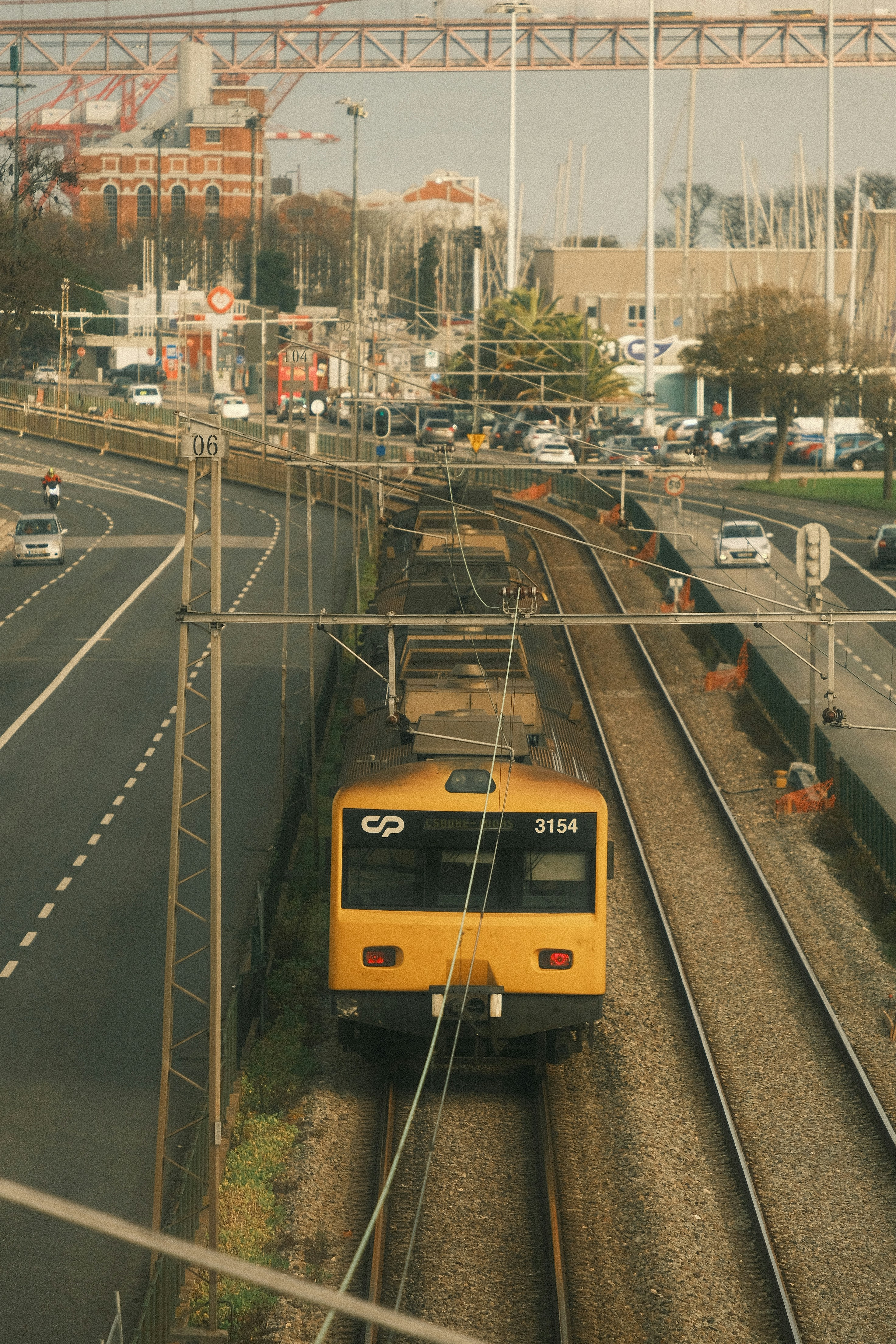Yellow Messenger on City Rails: A Train Crossing the Urban Wiring Vein