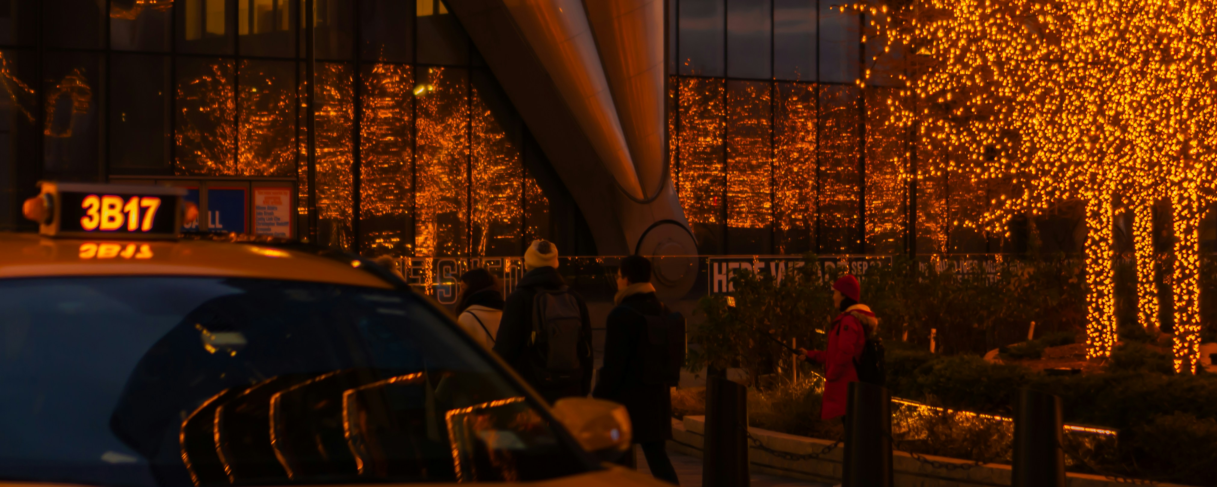 Night City Crossroads: Taxi Sign, Pedestrian Glow, and Illuminated Trees