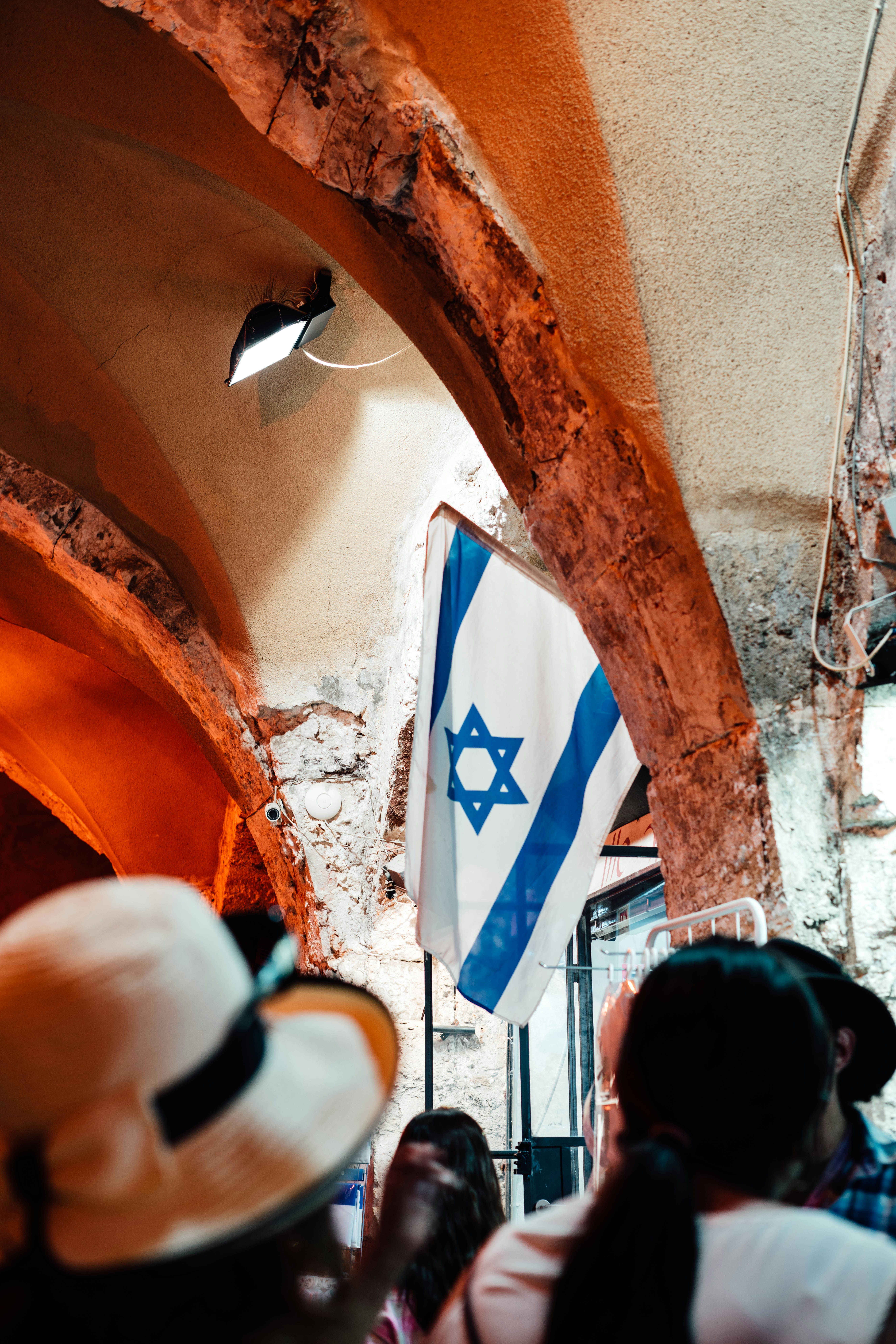 Blue Star Flag Beneath Timeworn Arches: A Quiet Gathering in a Stone Corridor