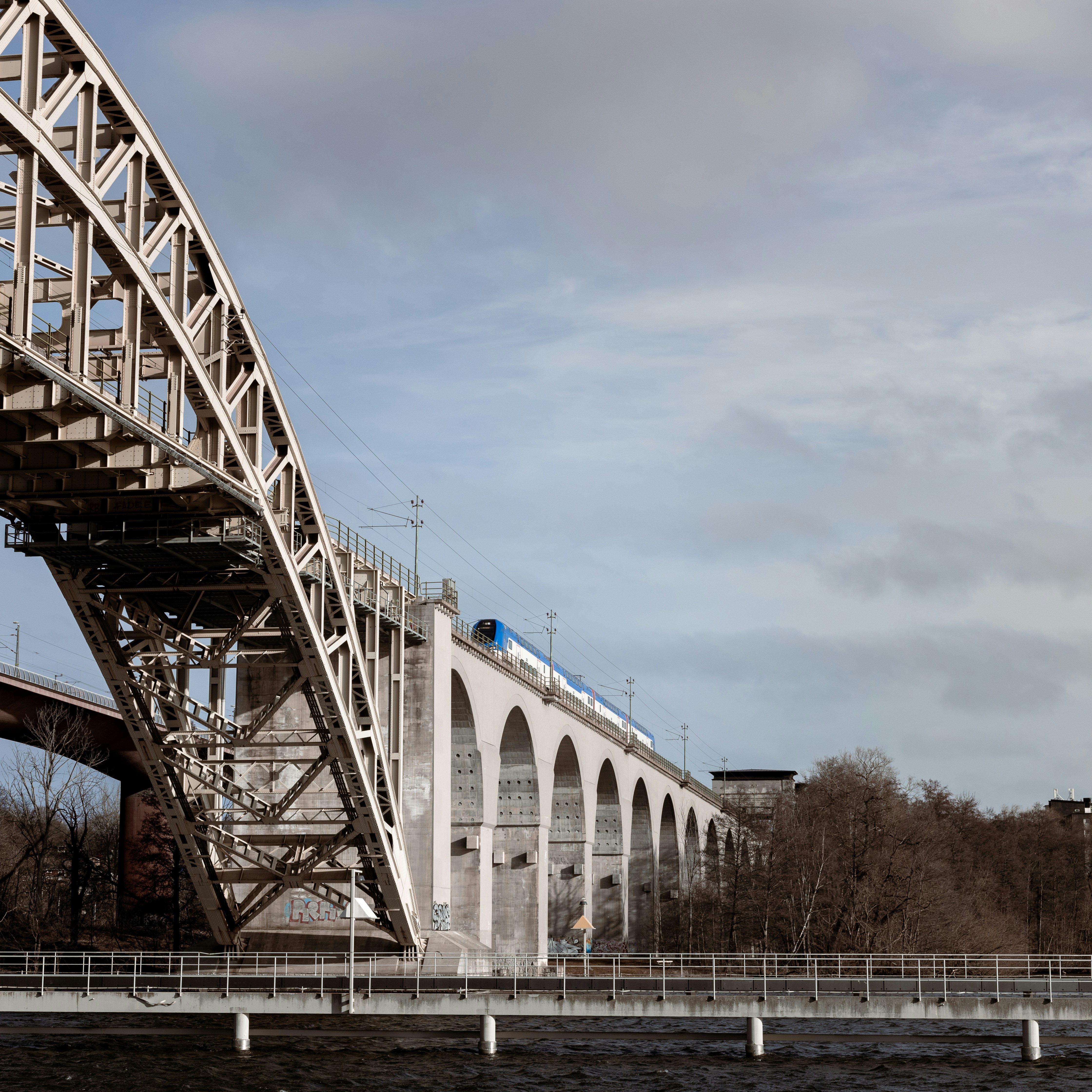 Rails in Focus: A Trainscape Crossing the River