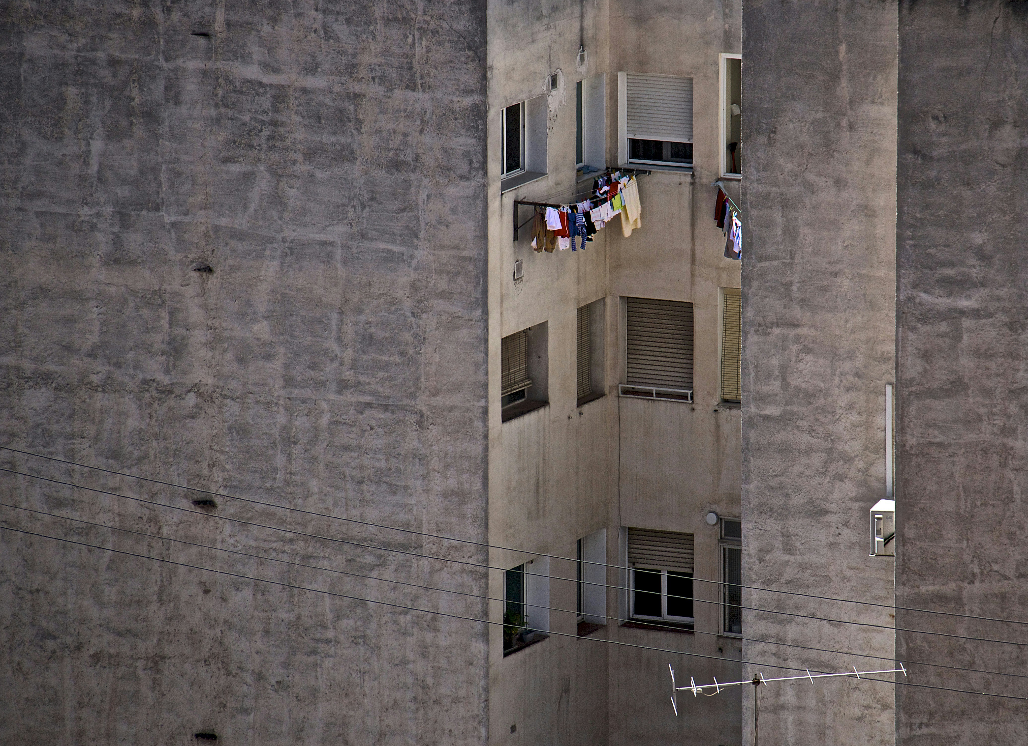 Clothesline Portrait in a Narrow Concrete Courtyard