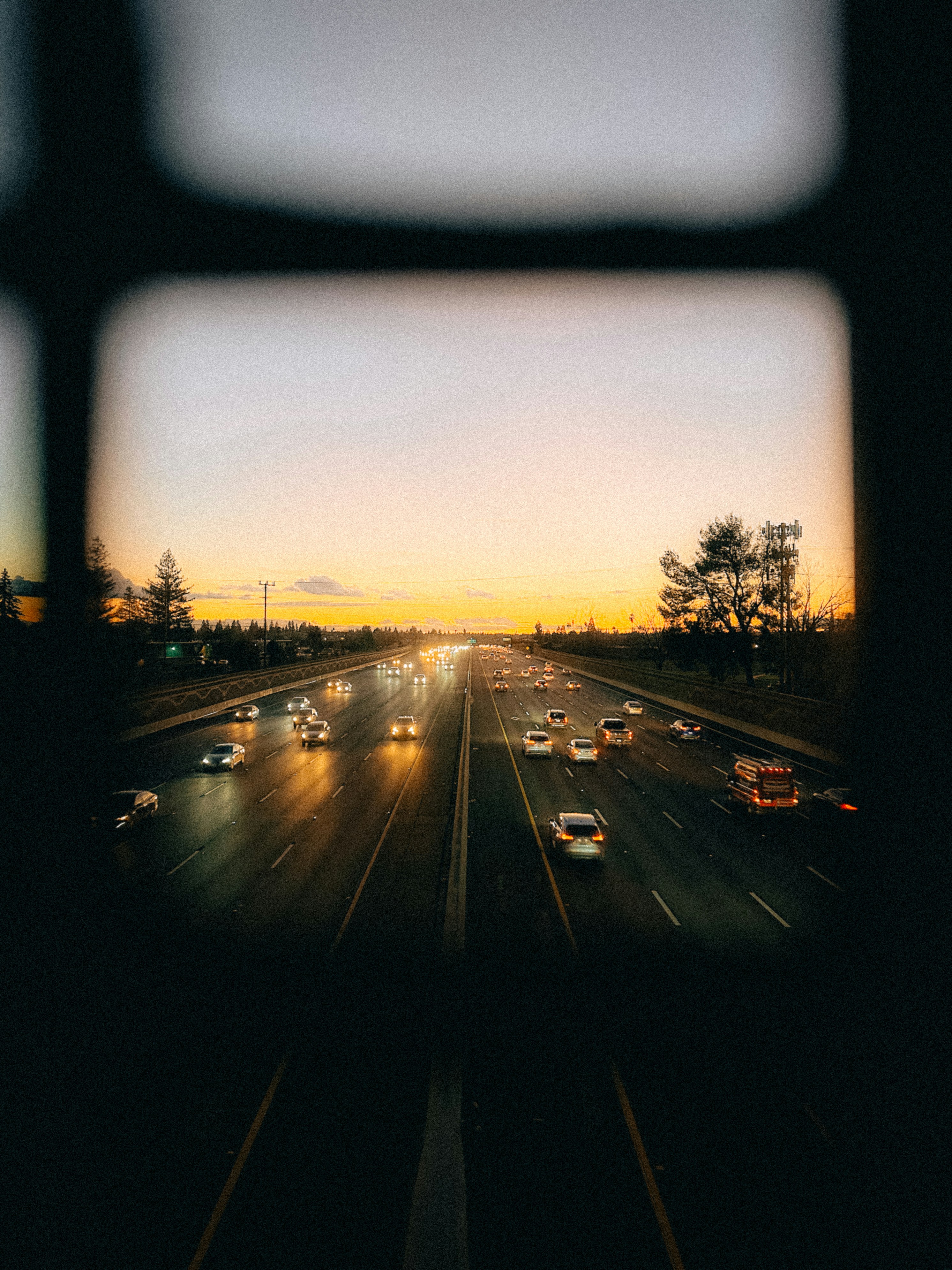 Dusk Convergence: The Sunset Highway Framed by a Windowed Veil