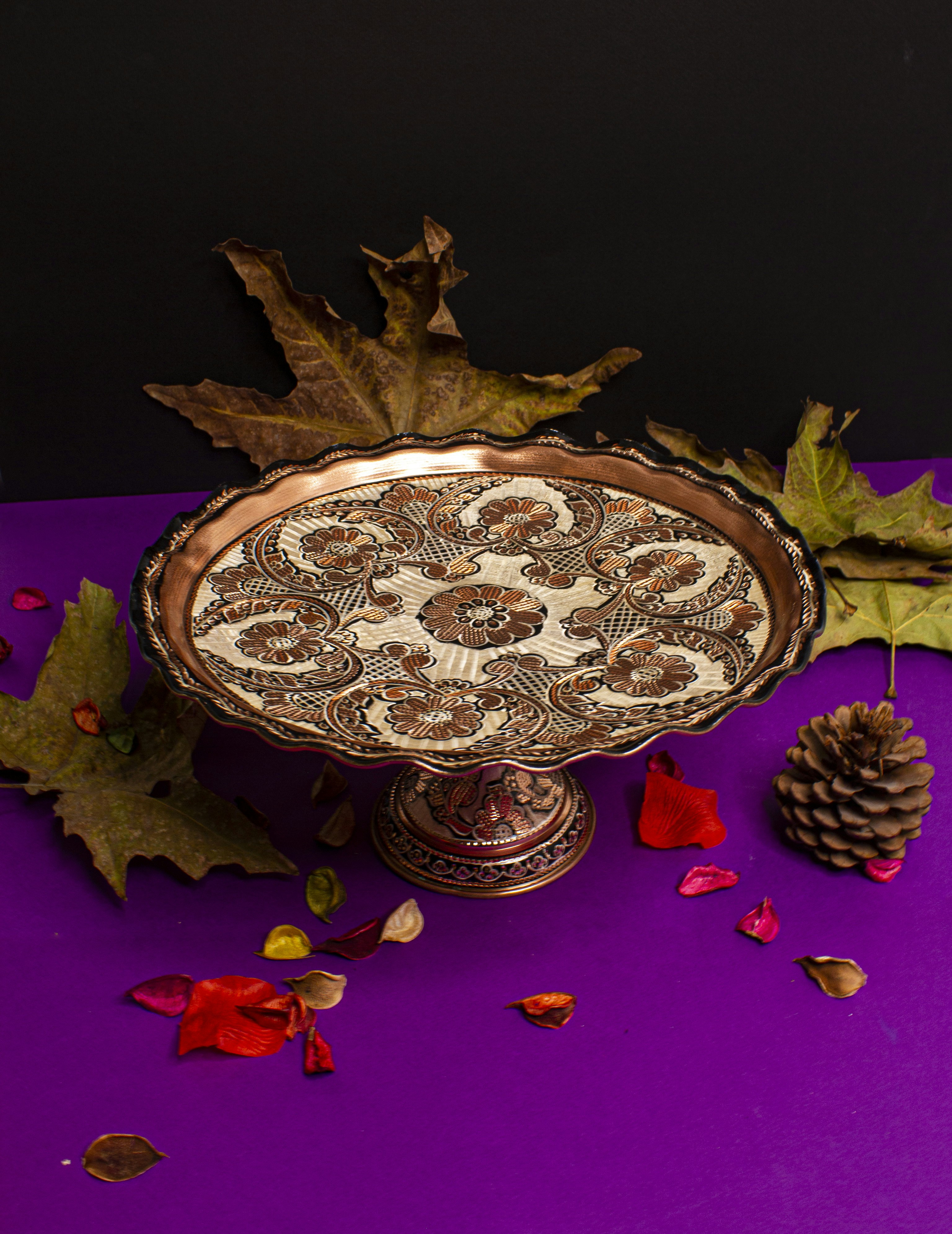 Ornate Pedestal Plate on a Violet Stage, Surrounded by Autumn Accents
