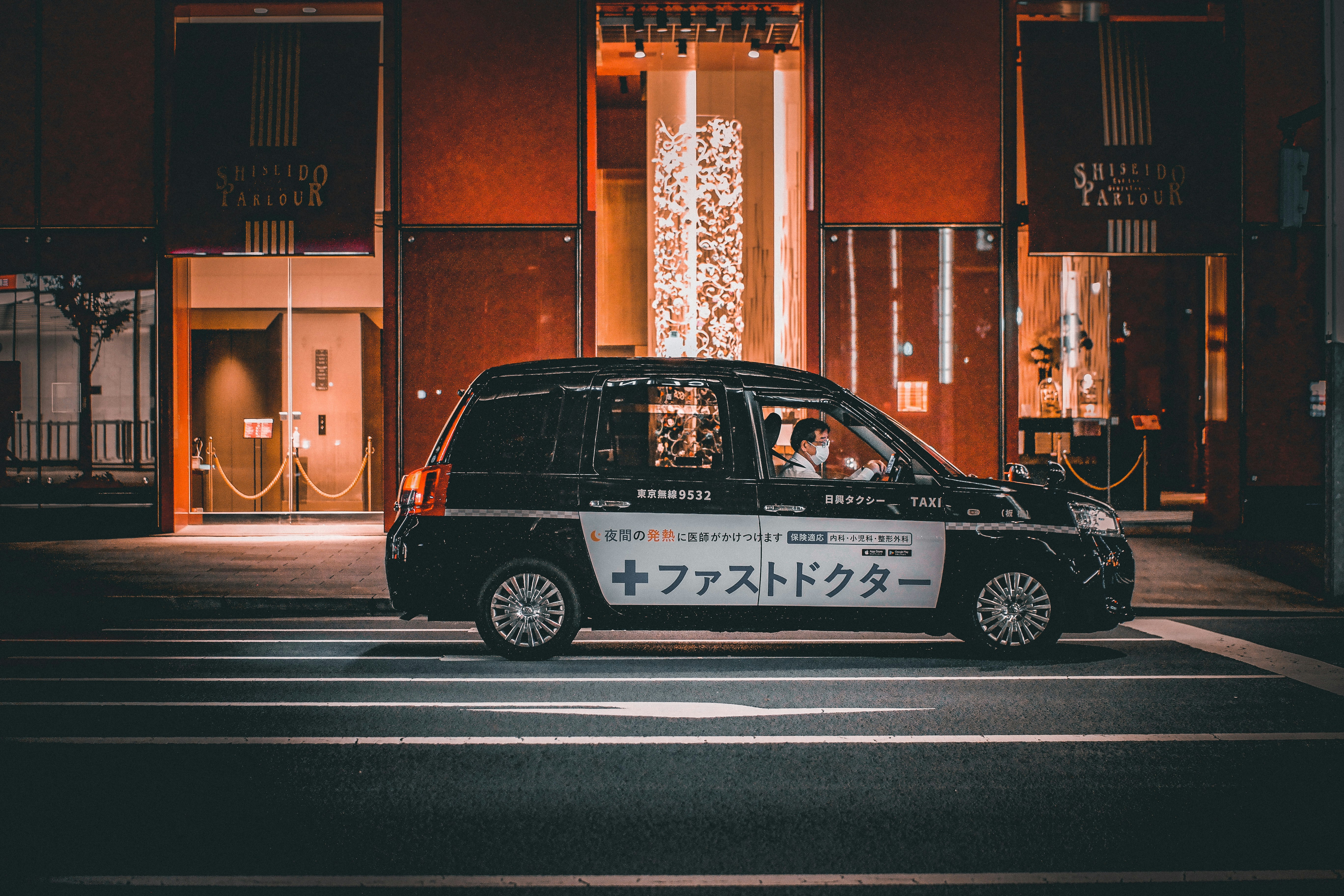 A taxi cab is parked in front of a building photo – Free Tokyo Image on ...