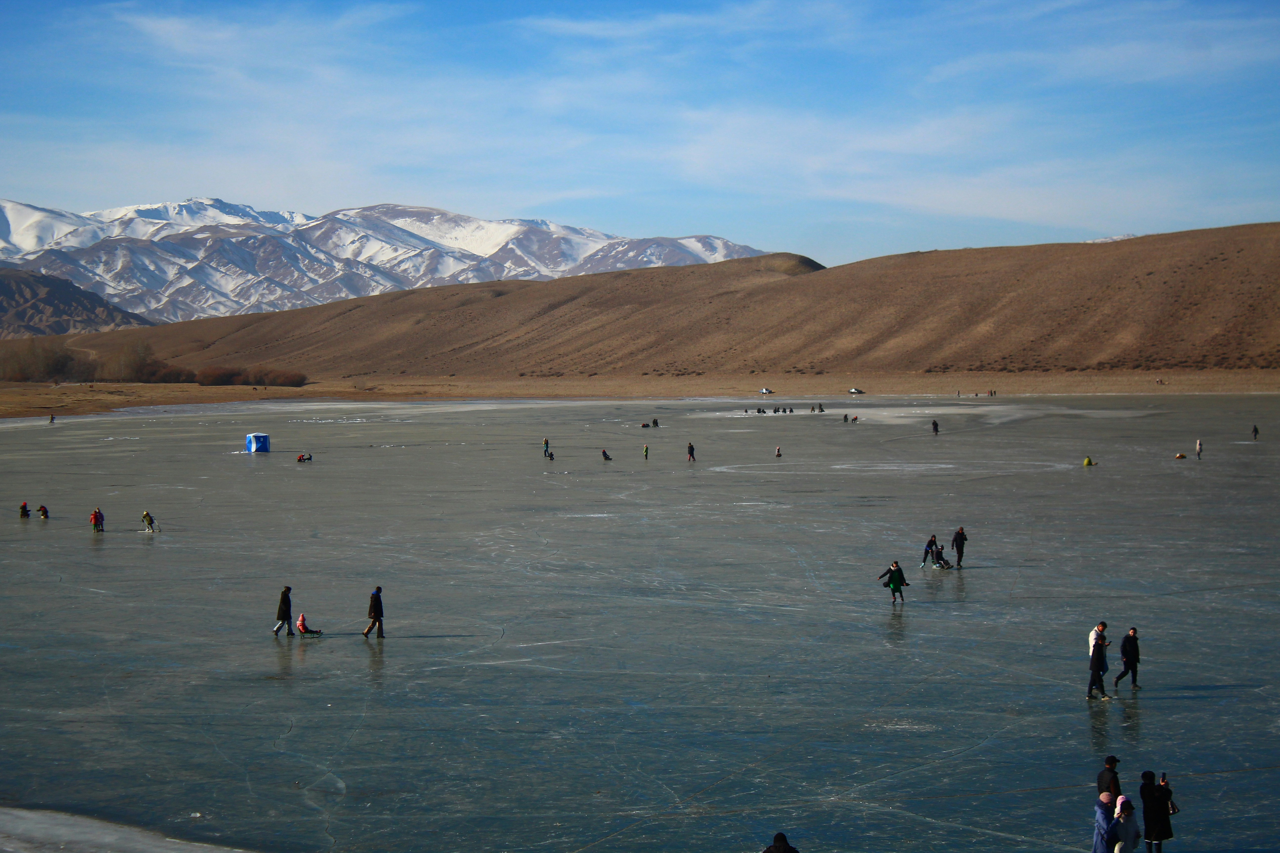 Glacier Mirror: Wanderers on a Frozen Lake with Alpine Backdrop