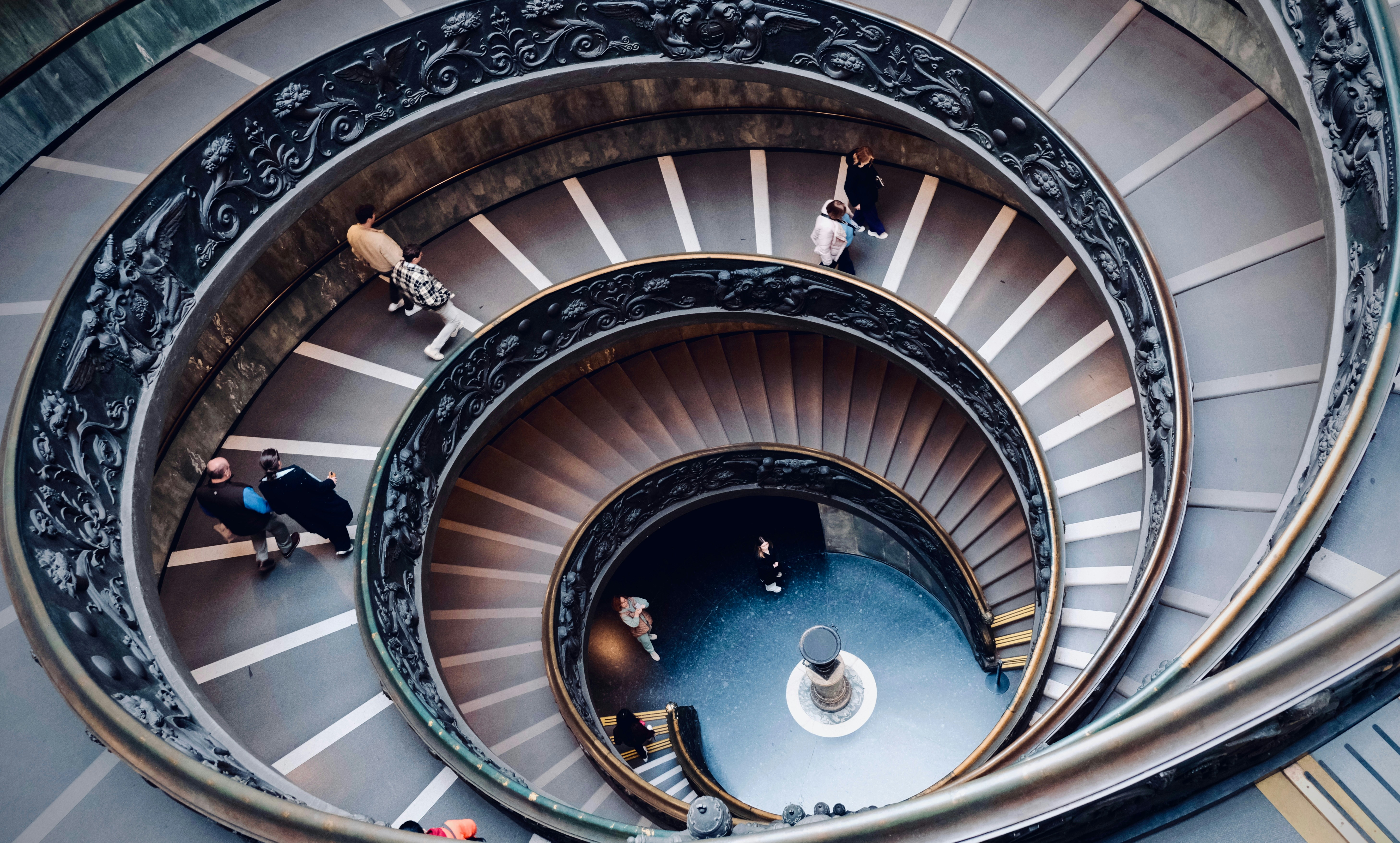 A group of people walking down a spiral staircase photo – Free Vatican ...