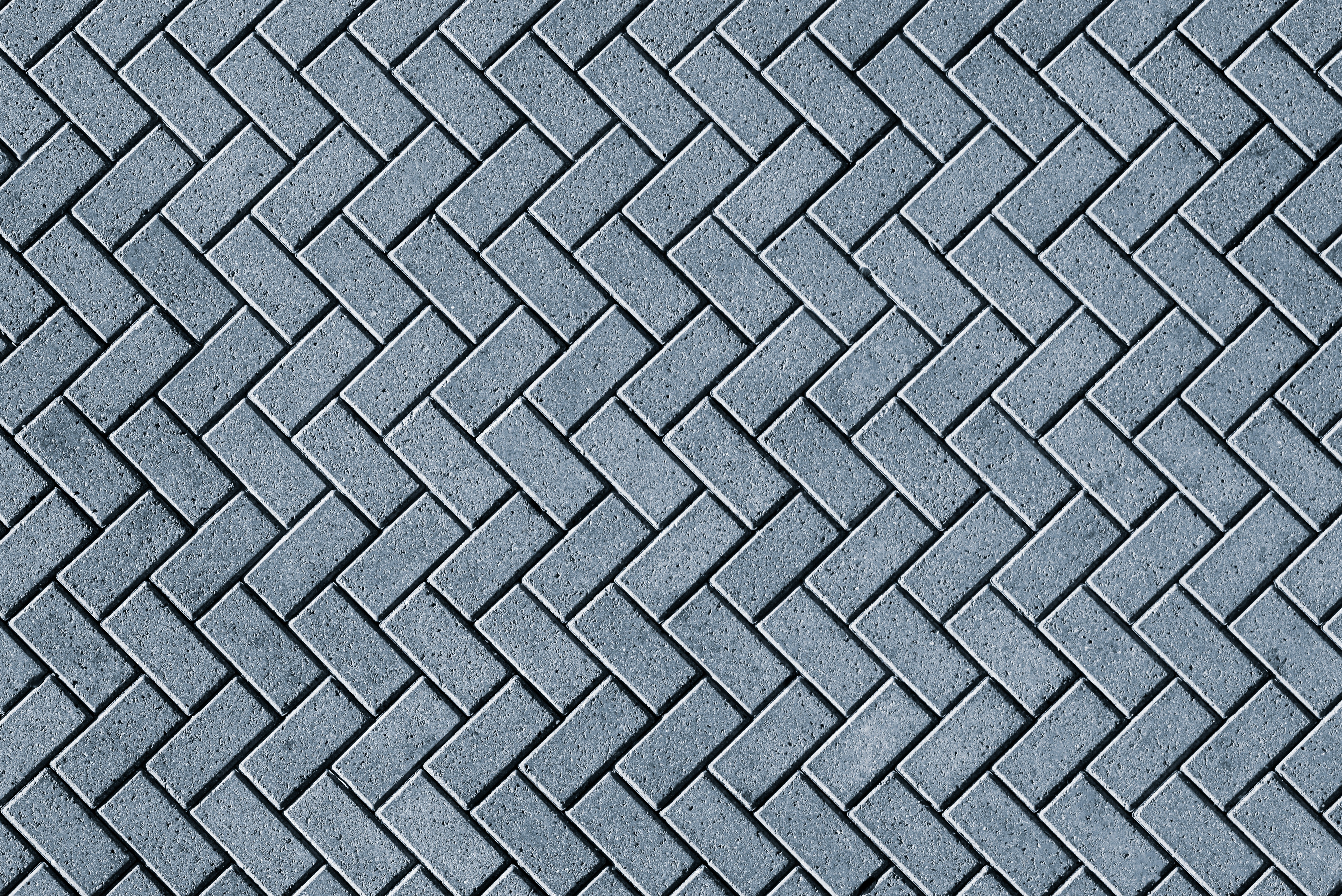 Gray Herringbone Tessellation: A Close-Up of Interlocking Pavers