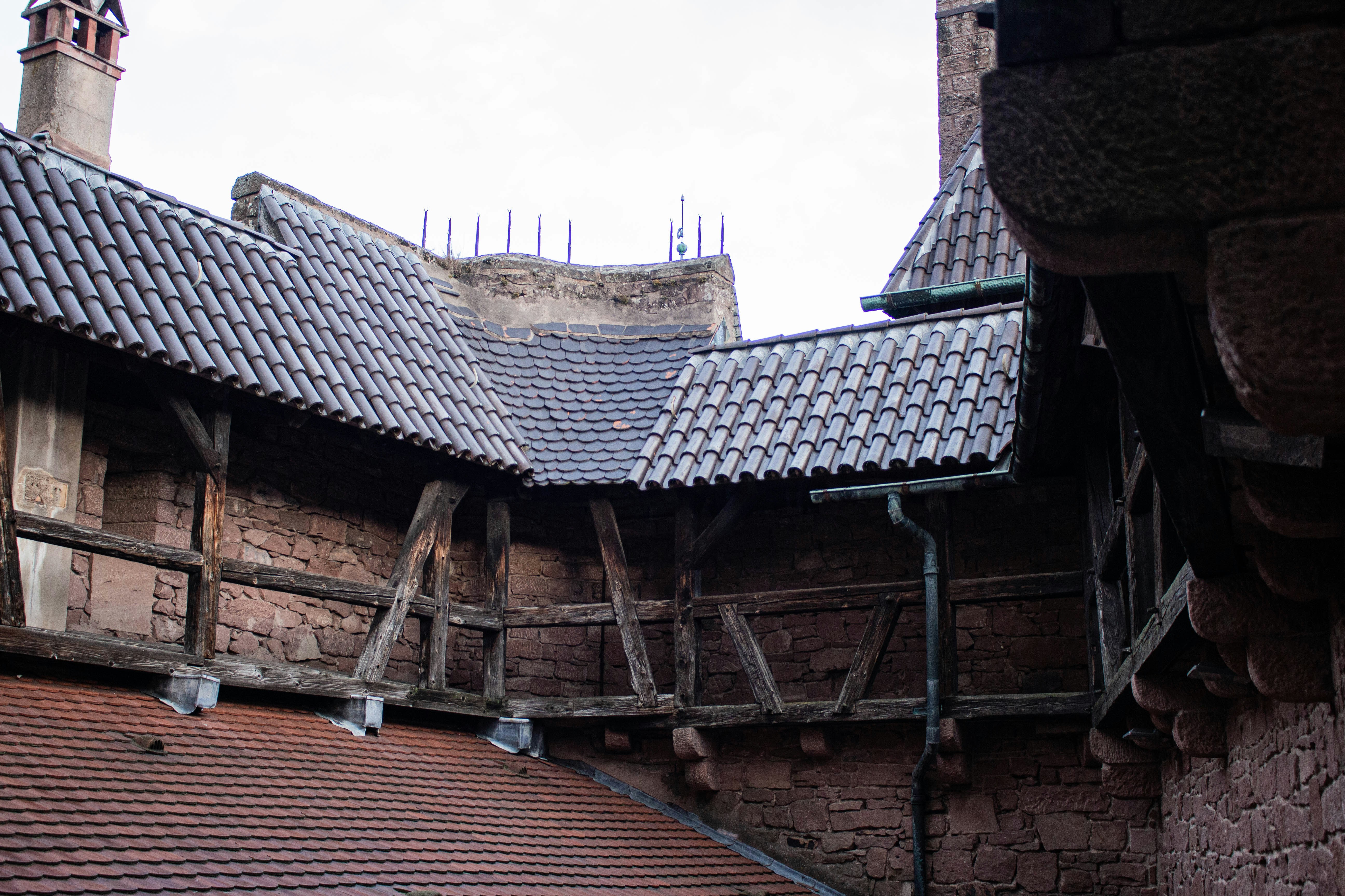 The roof of a building with a clock tower in the background photo ...