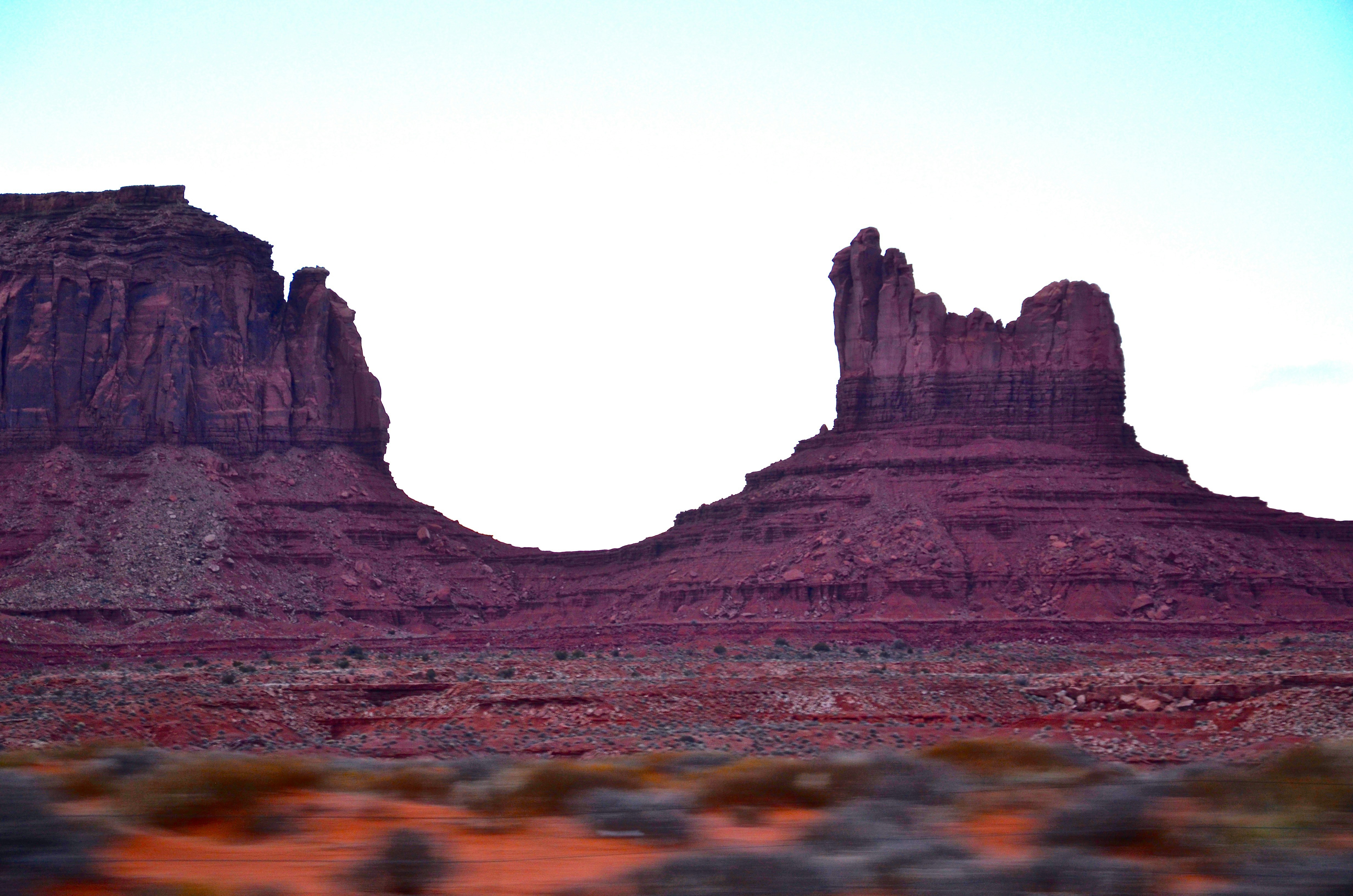 Desert Sentinels: Twin Mesas Against a Blurred Foreground