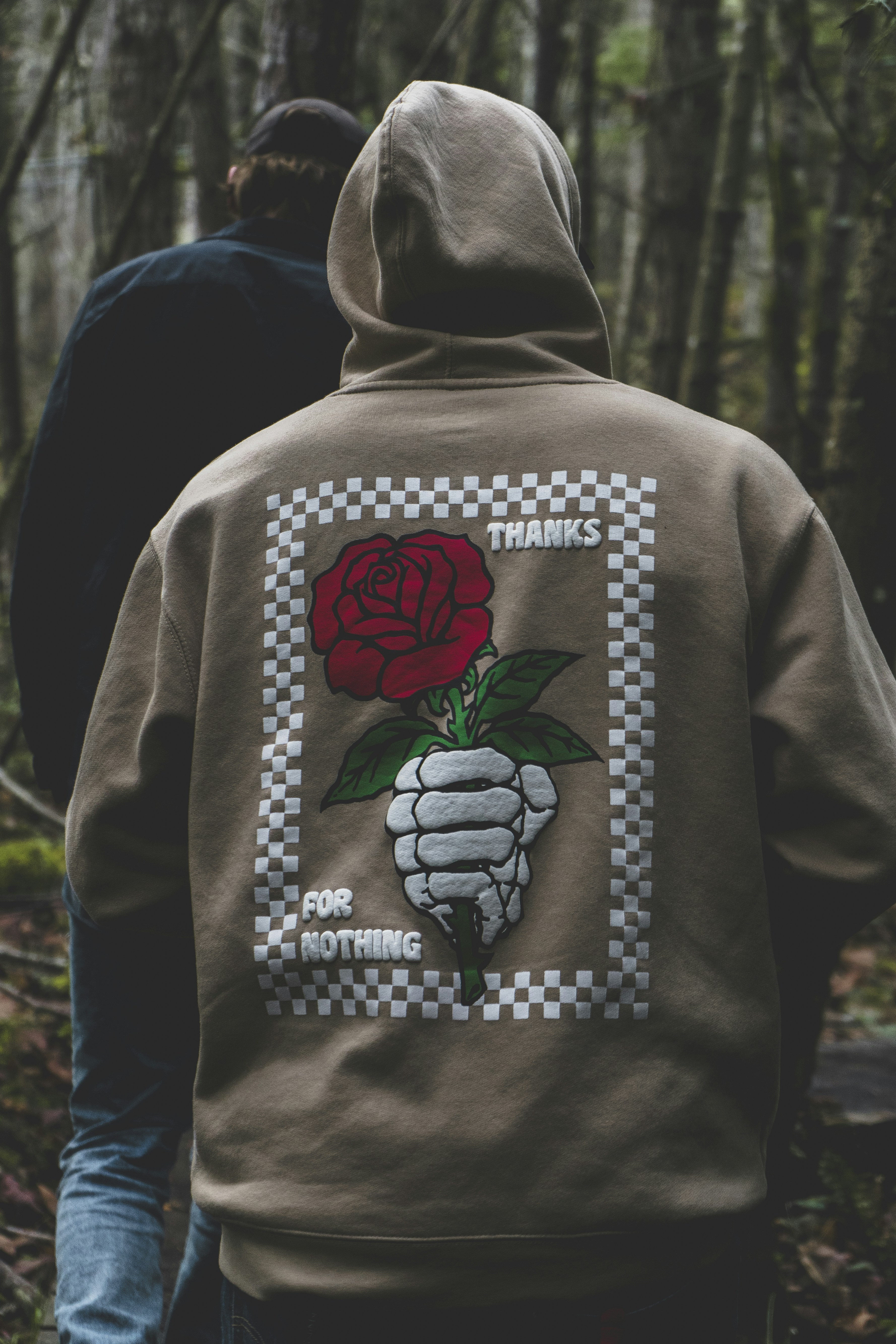 Rose in the Hood: a duo wanders through a mossy forest