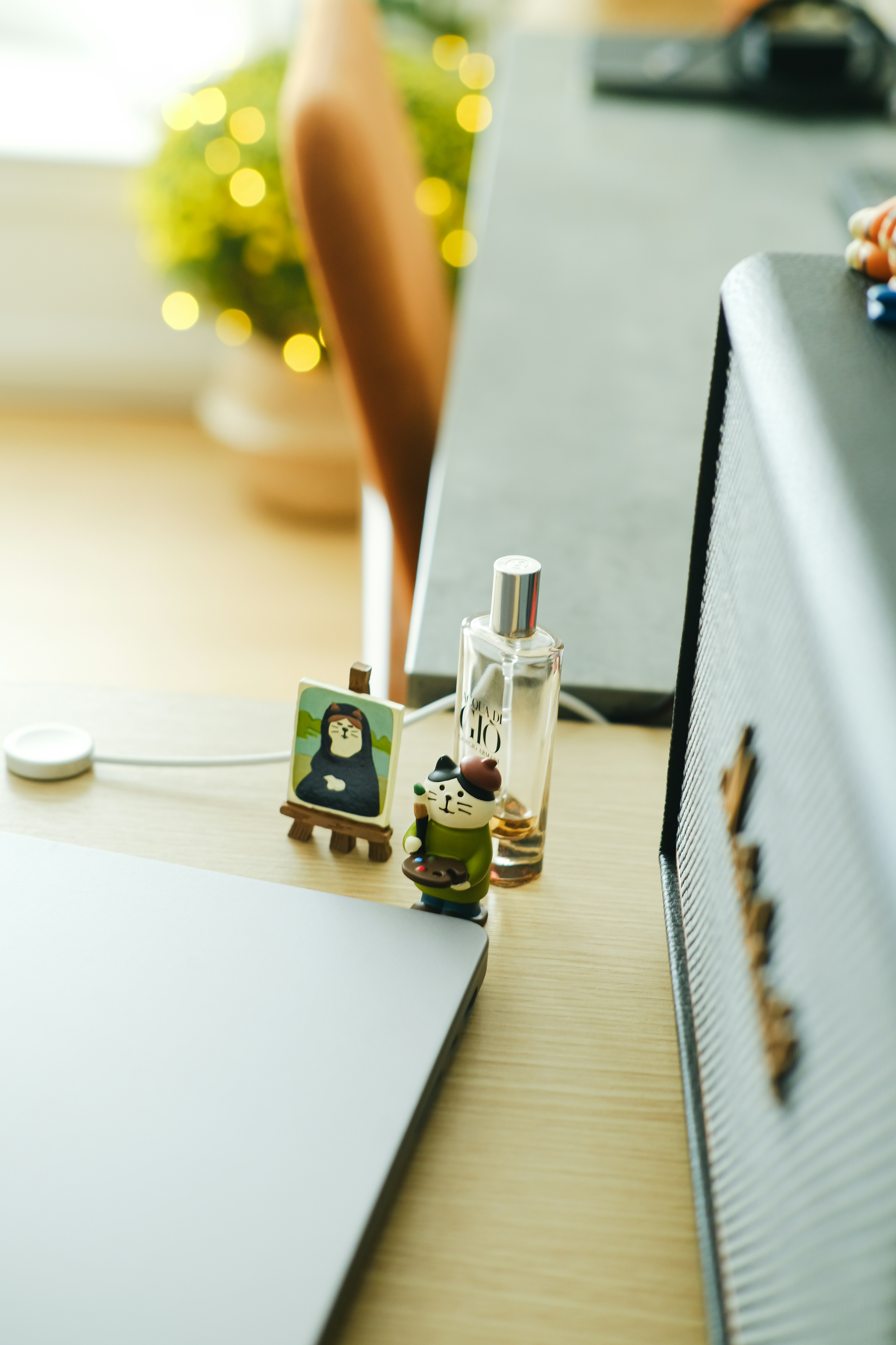 Desk-Top Whimsy: Tiny Figurines, Perfume, and a Speaker in Soft Focus