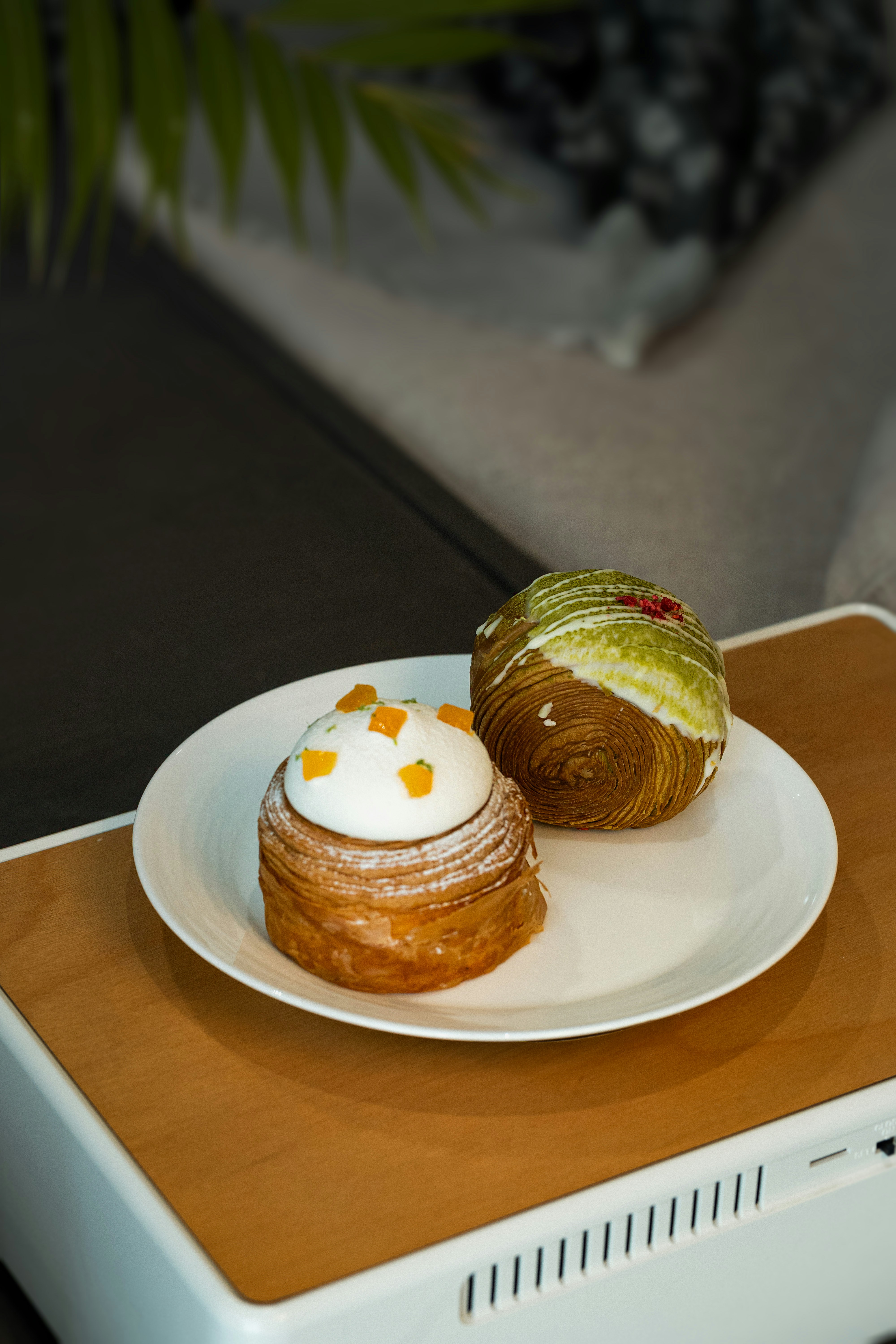A white plate topped with a pastry on top of a wooden table photo ...