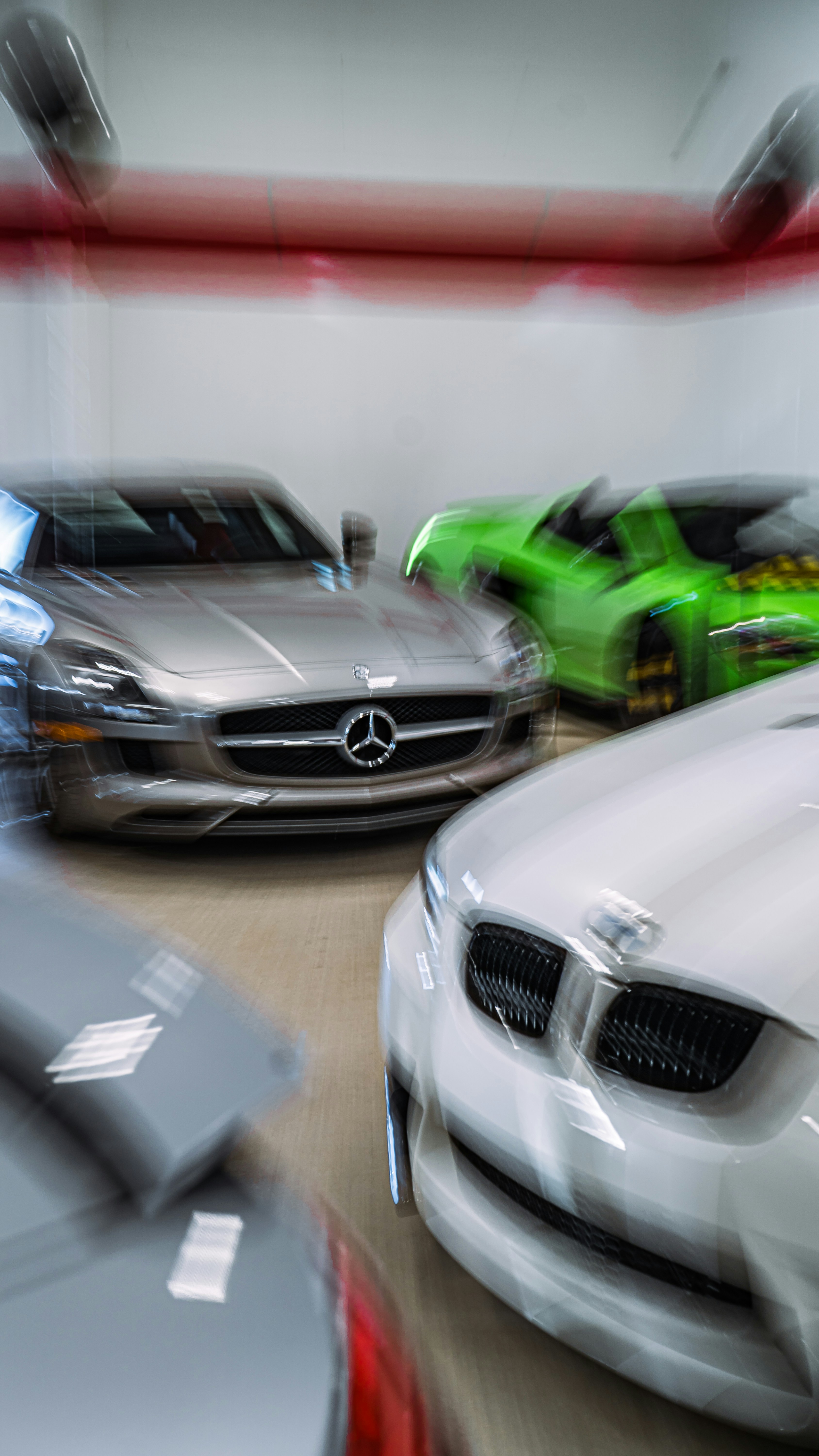 A blurry photo of a bunch of cars in a garage photo – Free Mercedes ...
