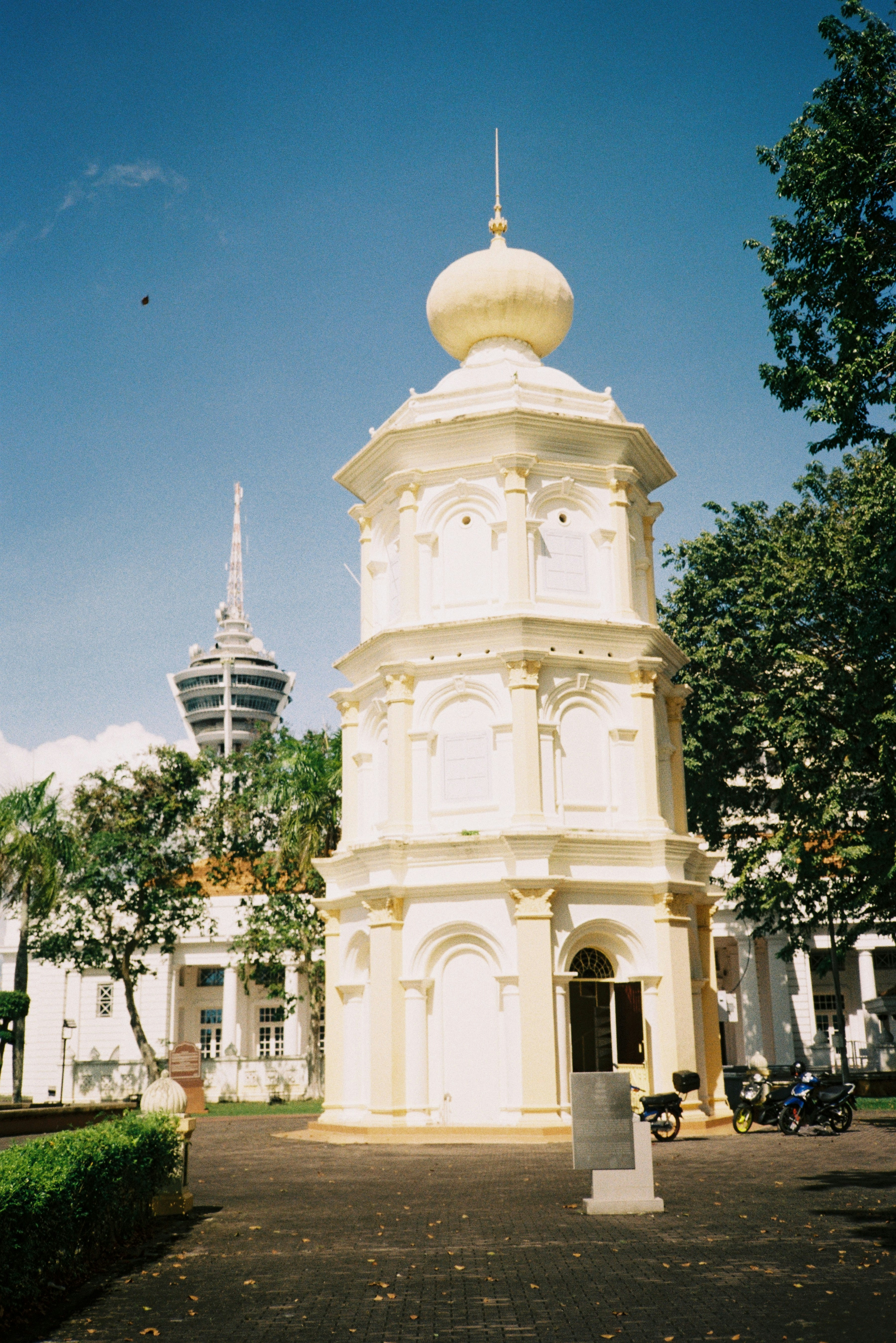 A tall white tower with a clock on the top of it photo – Free Alor ...