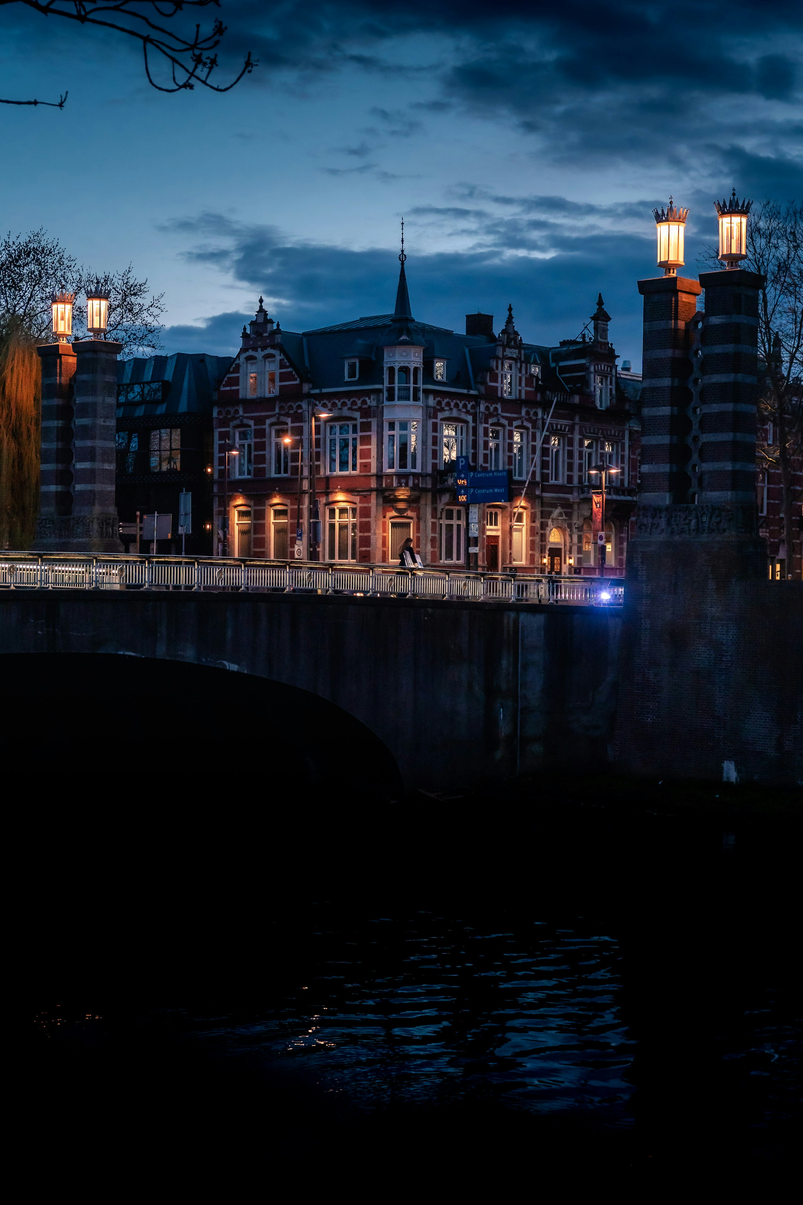 A night scene of a city with a bridge and buildings photo – Free Den ...