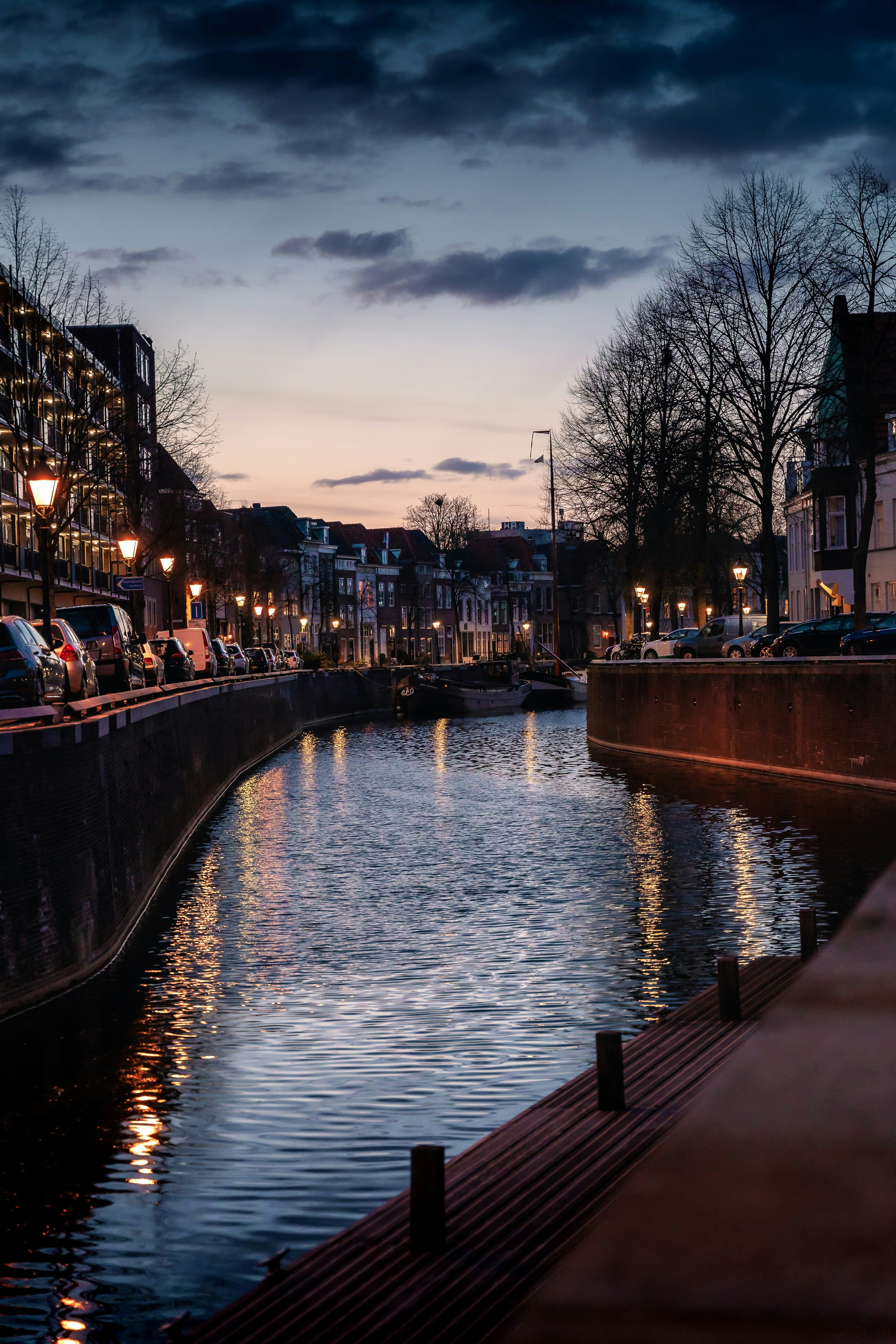 A river running through a city next to tall buildings photo – Free Den ...