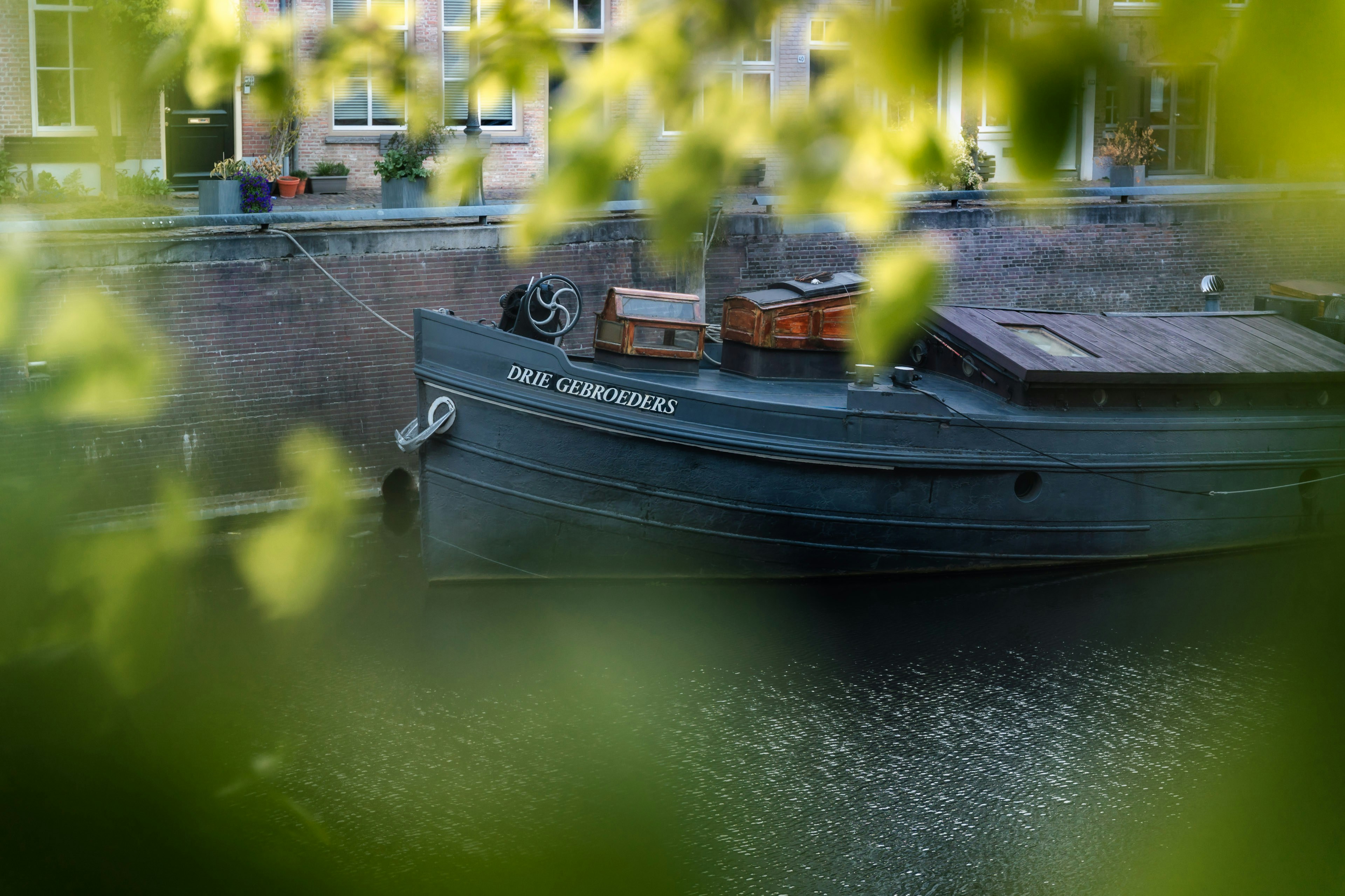 Boat at Rest on a Calm Canal Framed by Greenery