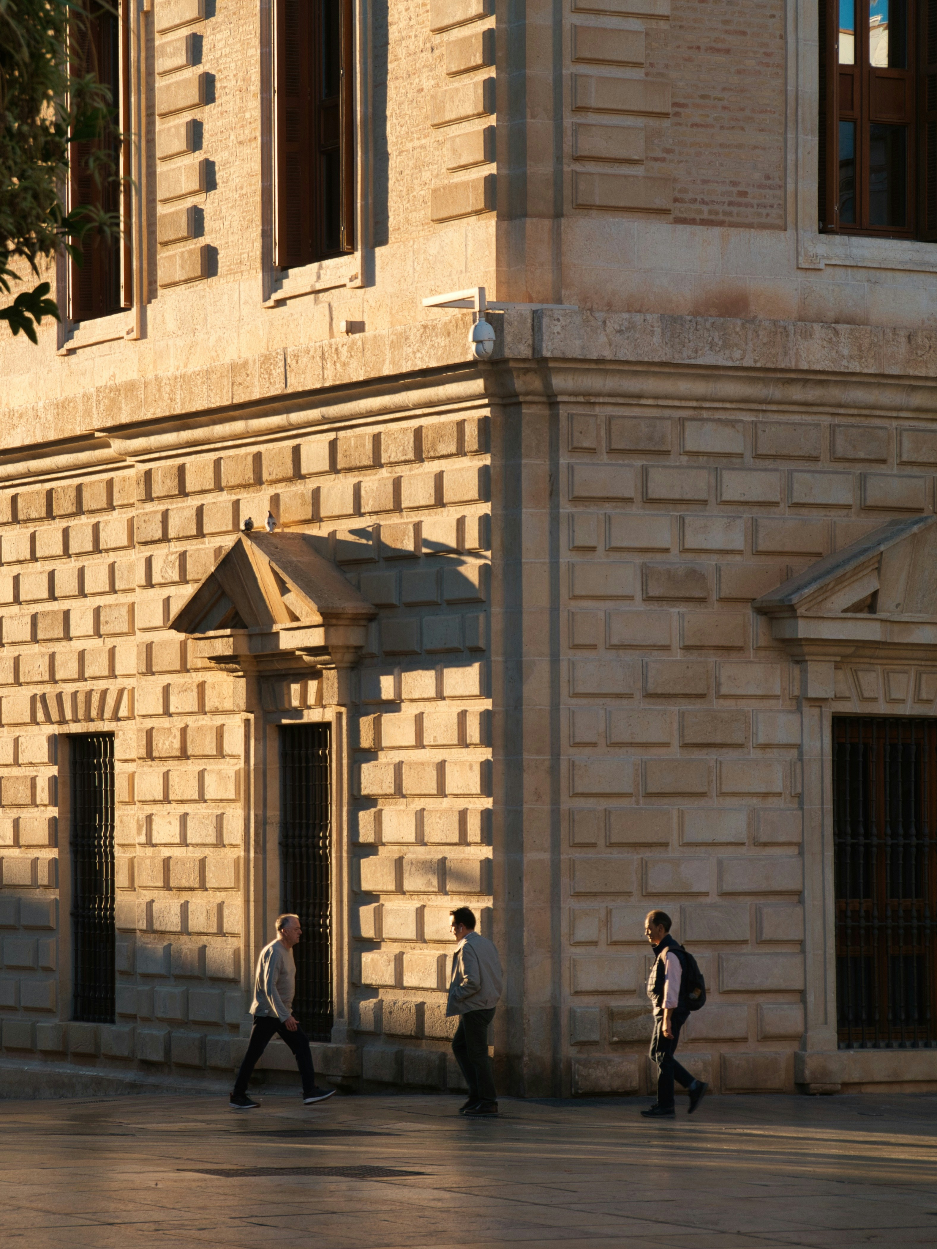 Sunlit Strides Along a Beaux-Arts Corner